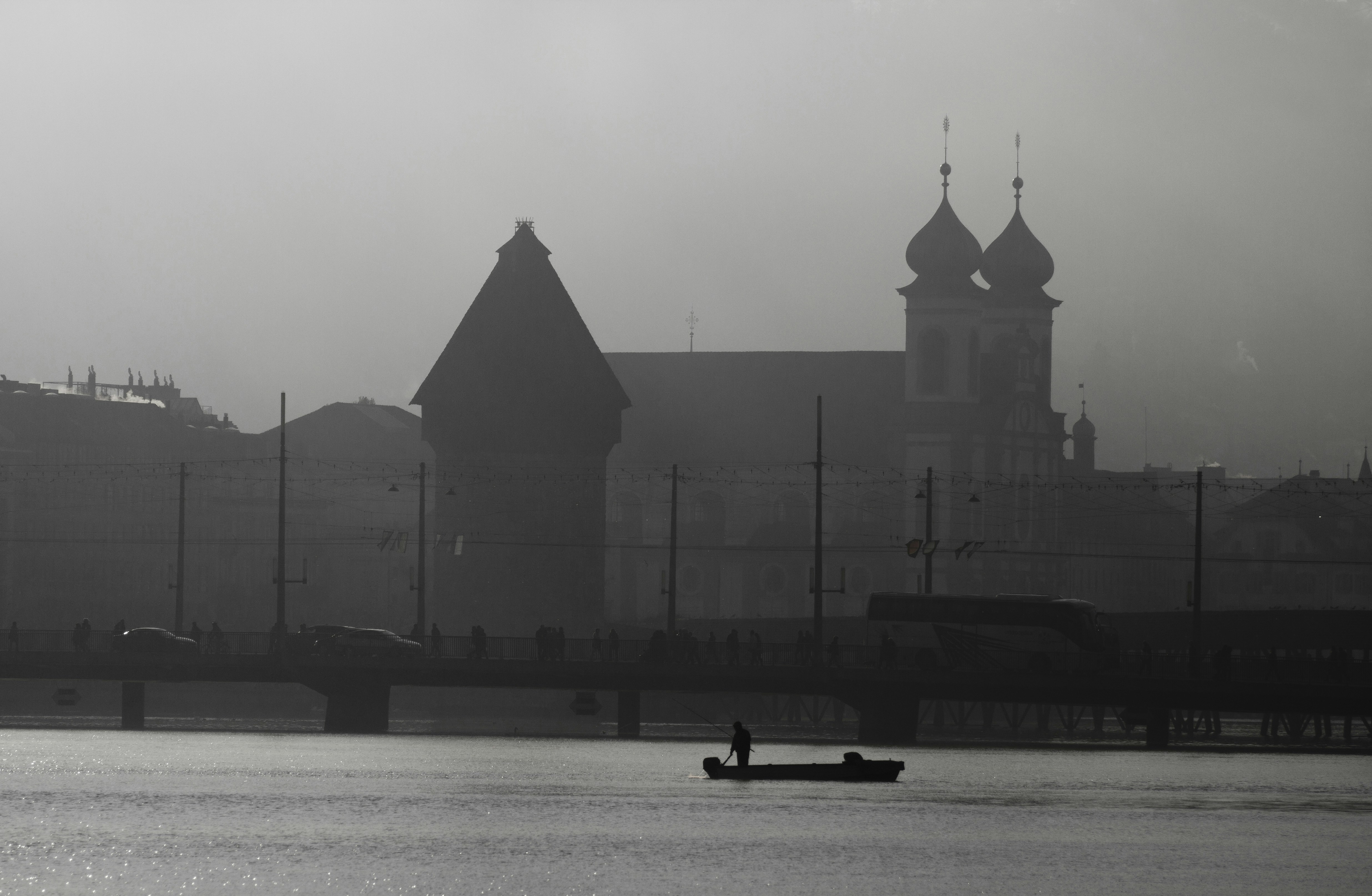 Fog-Quiet Riverfront: A Lone Boat Beneath Onion-Domed Towers