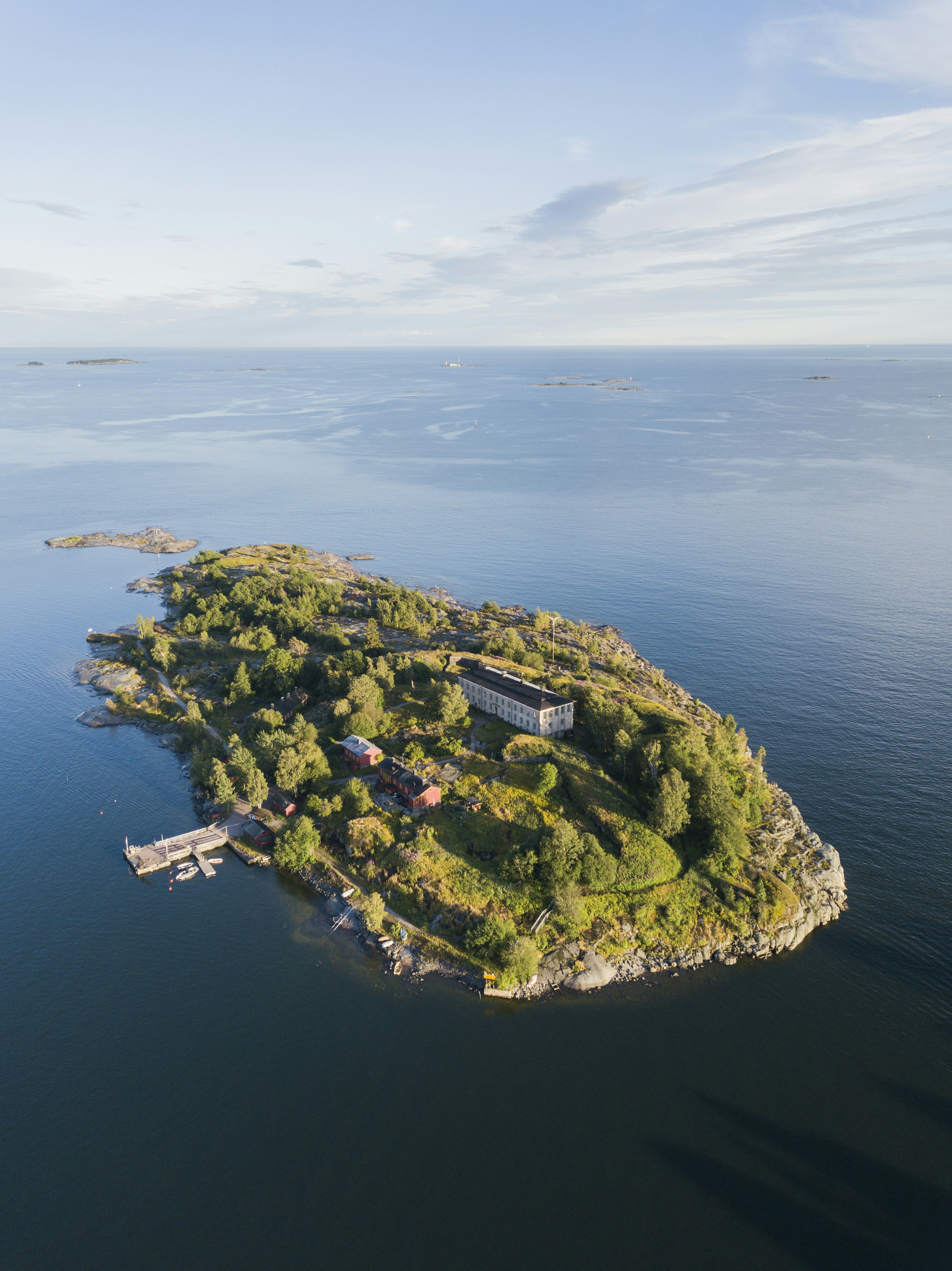 Rocky Promontory Retreat: A Pine-Covered Island House with a Quiet Dock