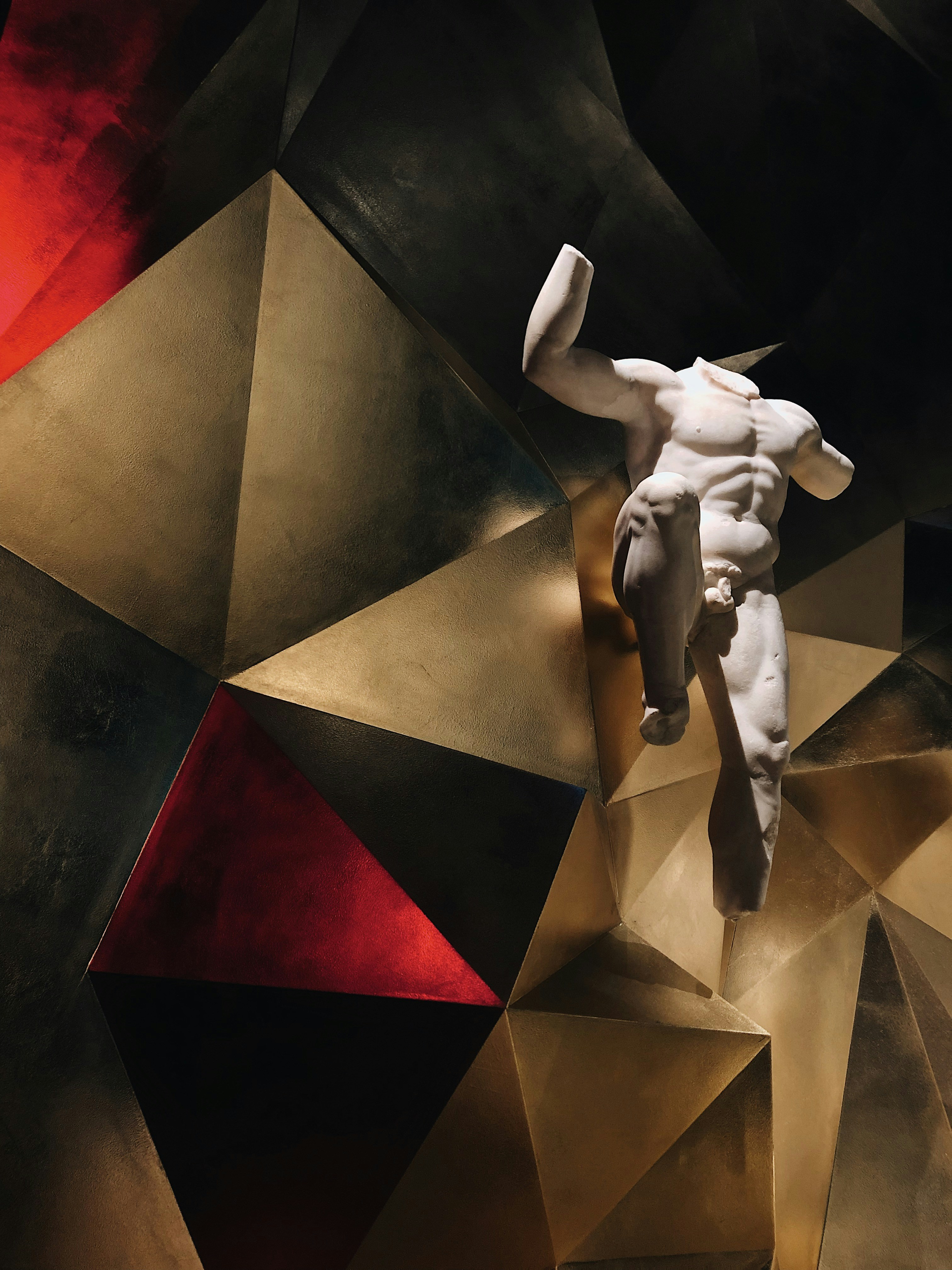 Crucible of Form: A Marble Figure Against Faceted Gilded Walls