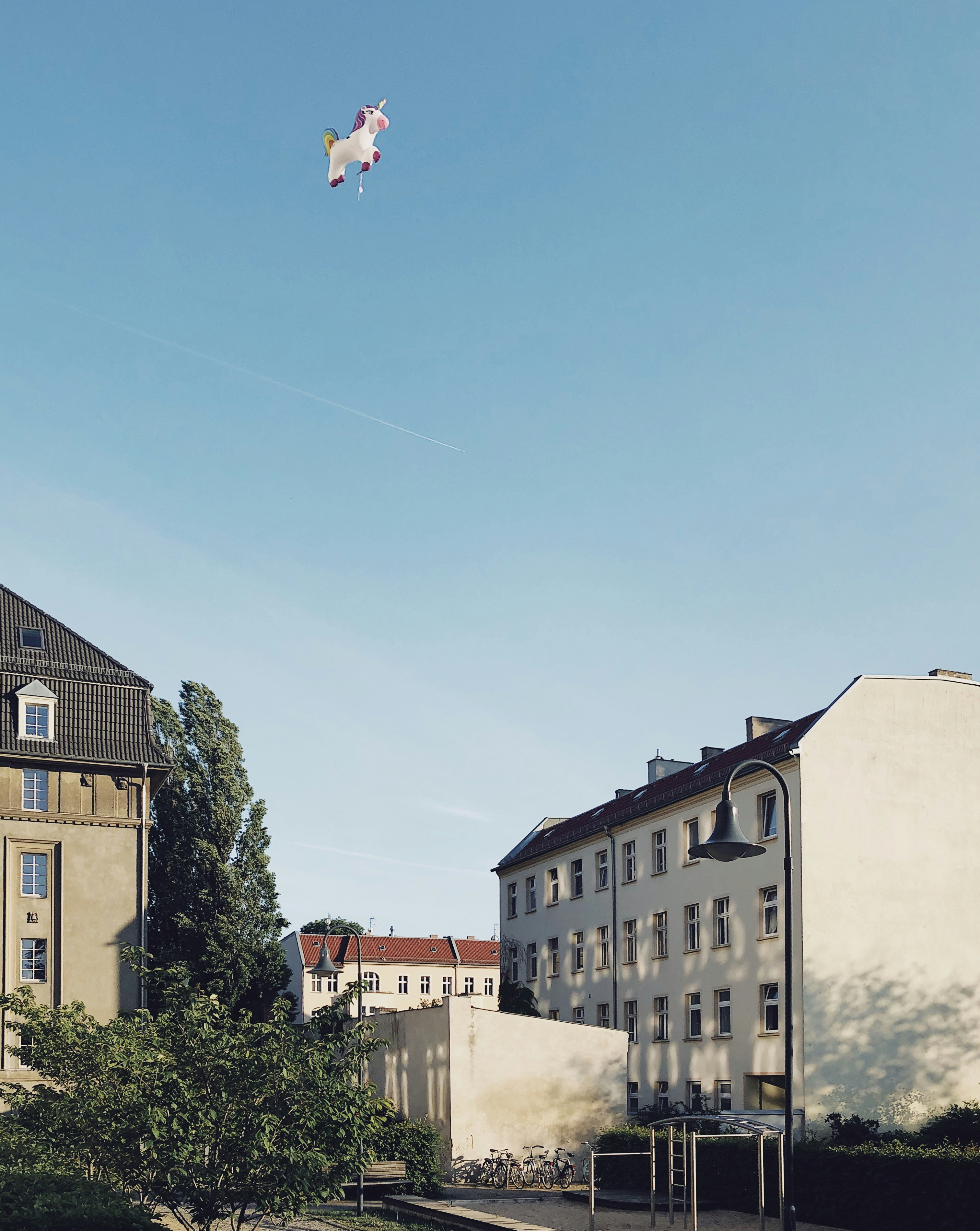 Unicorn Kite Over Quiet Cityscape