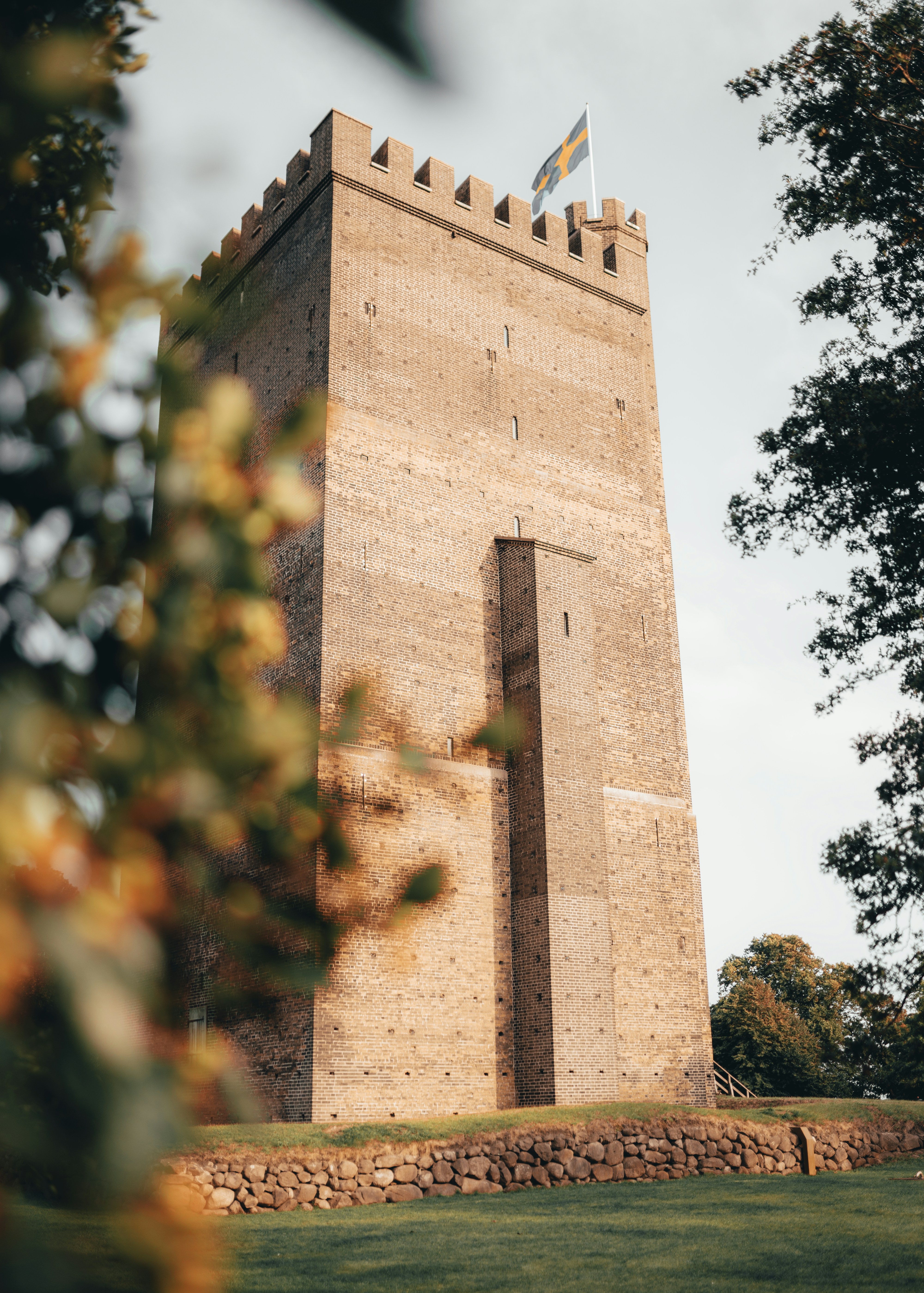 A tall tower with a flag on top of it photo – Free Brown Image on Unsplash