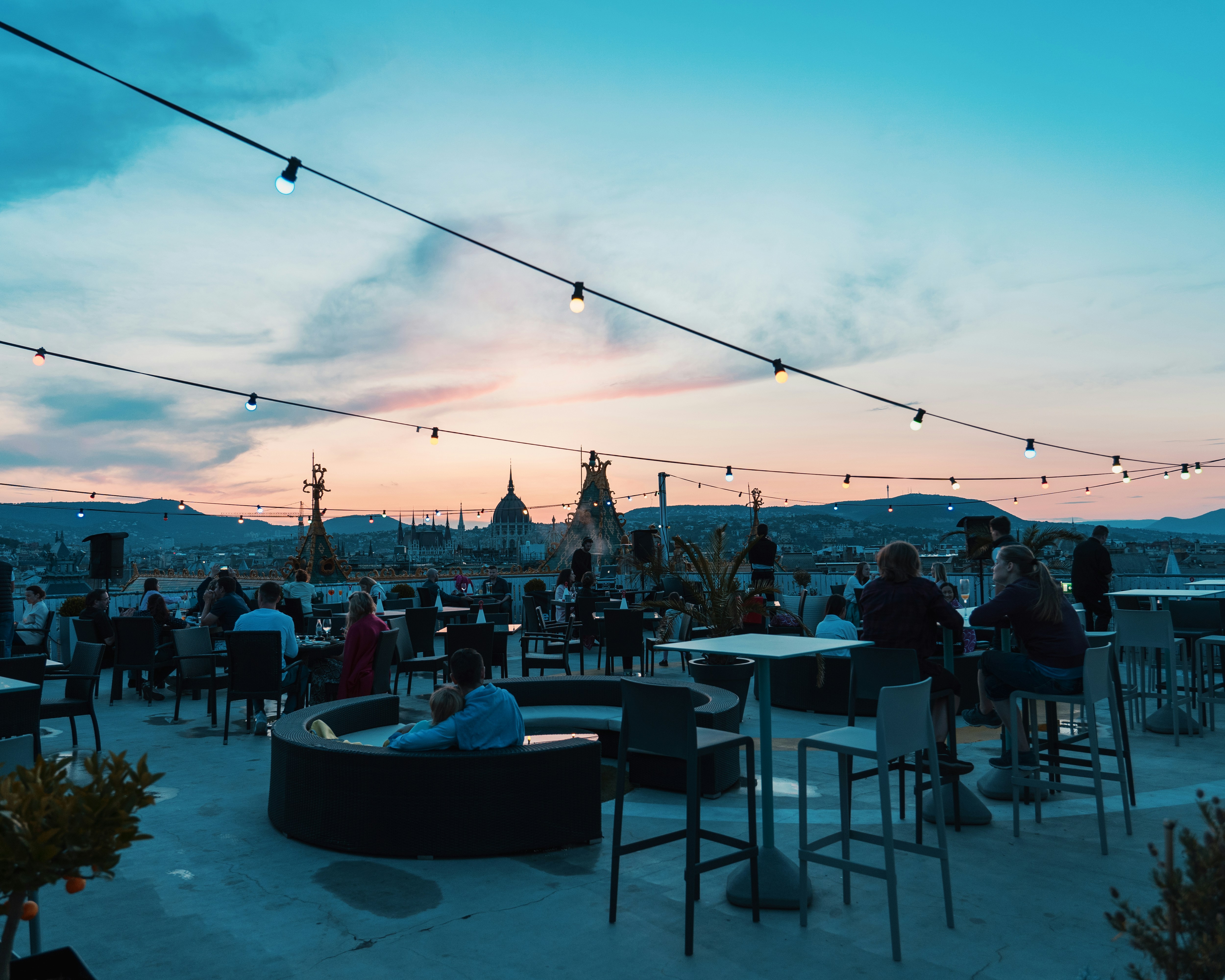 Twilight Terrace: Lanterns, Loungers, and a Distant Domed Skyline