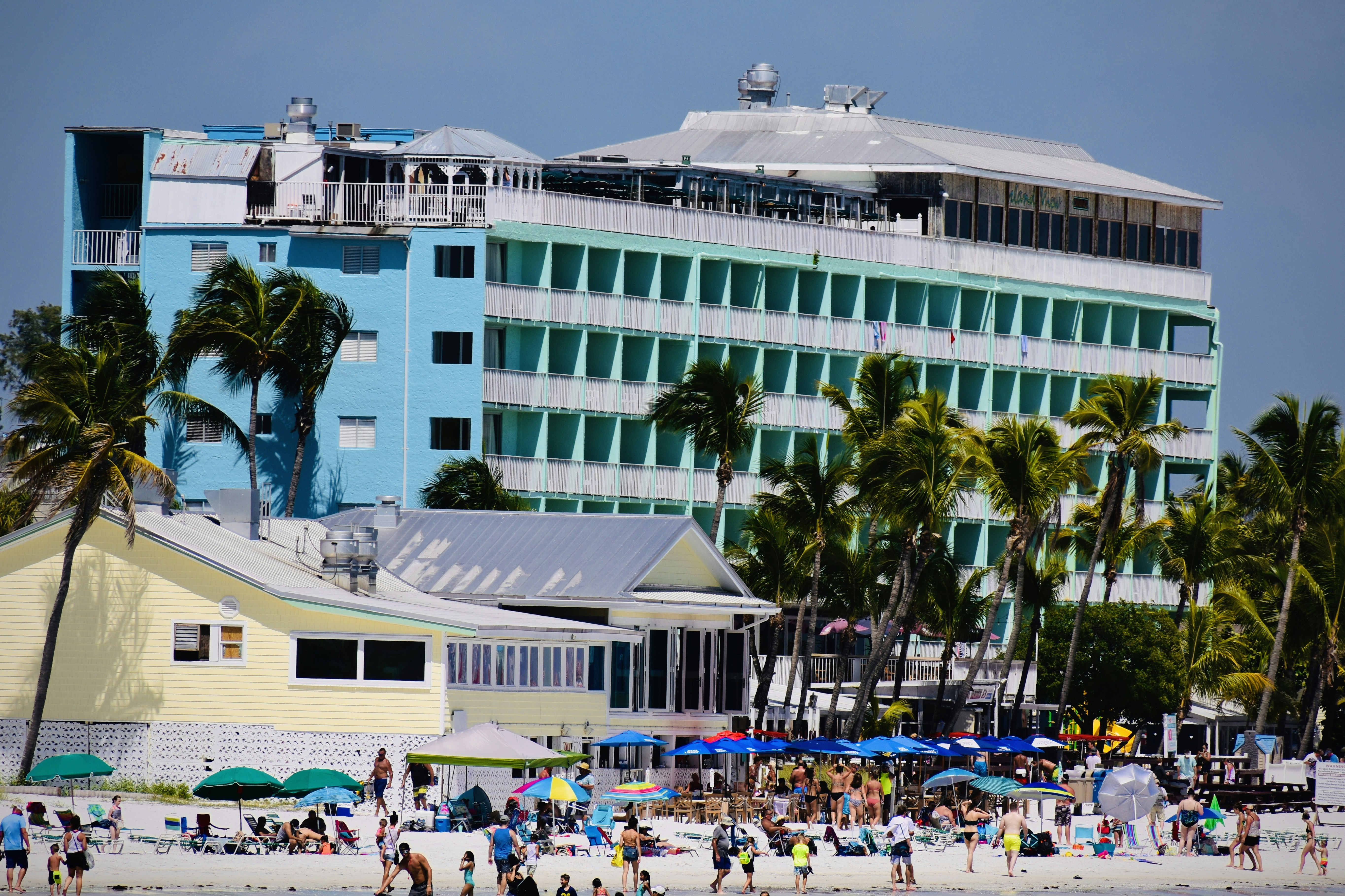 Azure Tower by the Palm Shore: A sunlit beachfront resort scene