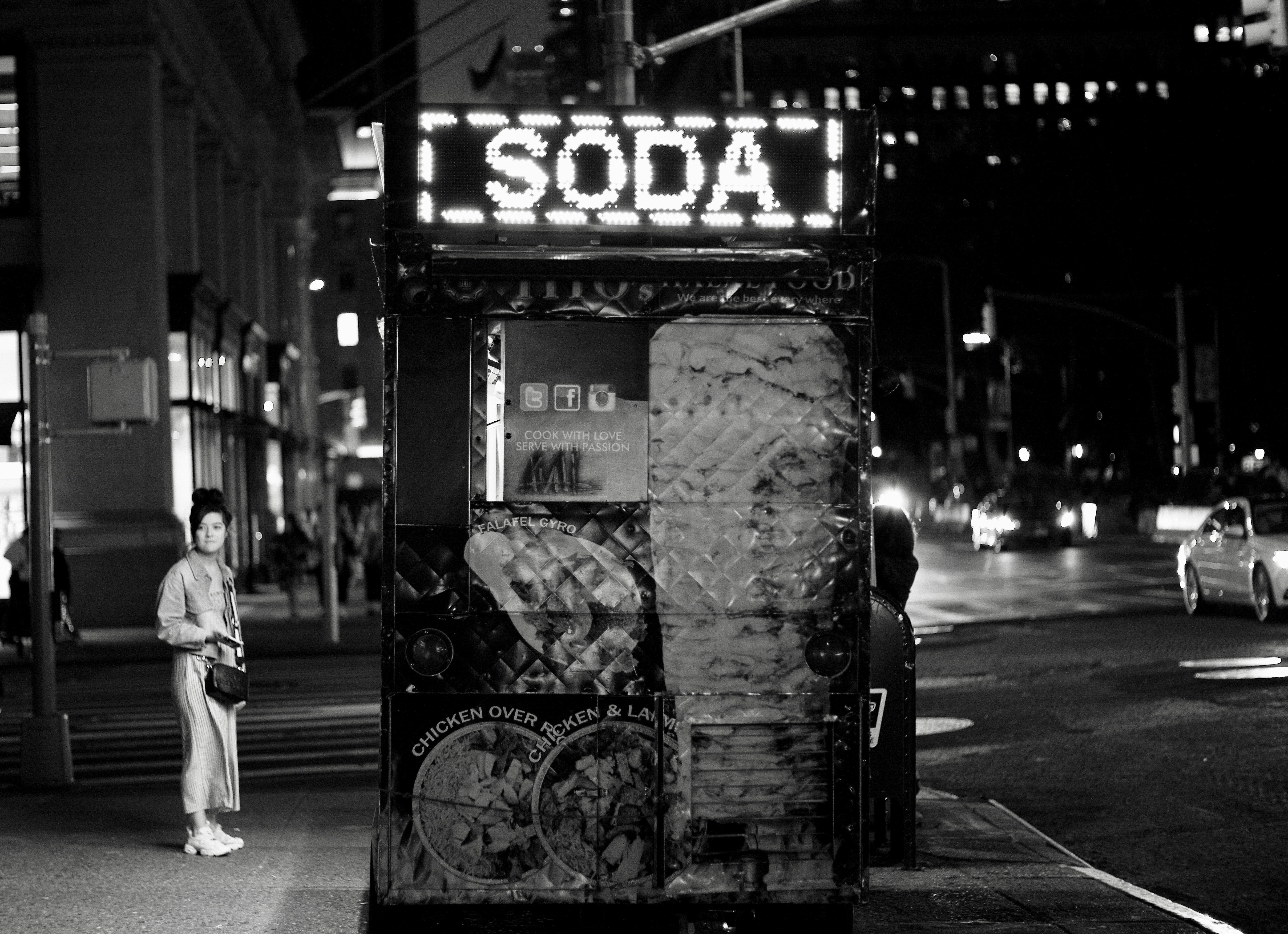 Neon Soda Cart at Night: A Quiet City Street in Mono