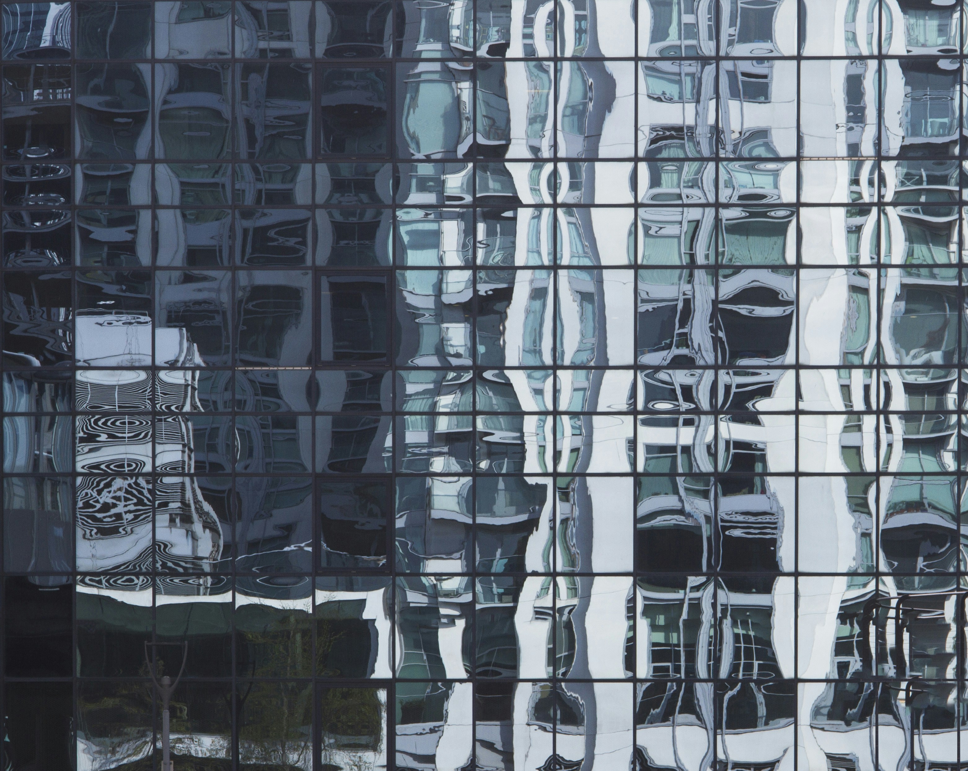Waves on a Glass Curtain: Distorted City Reflections