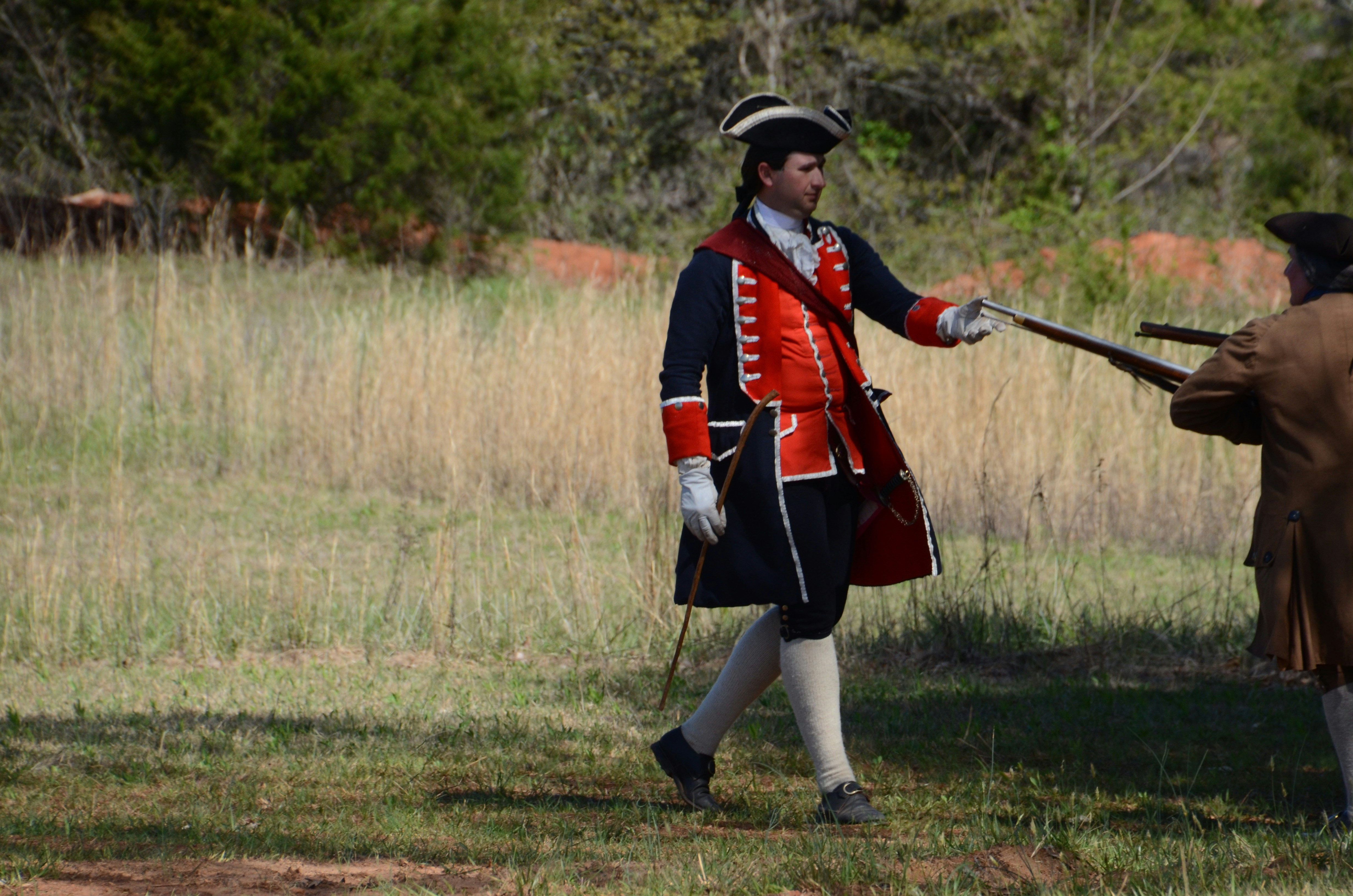 Redcoat Reenactment Standoff in a Sunlit Field