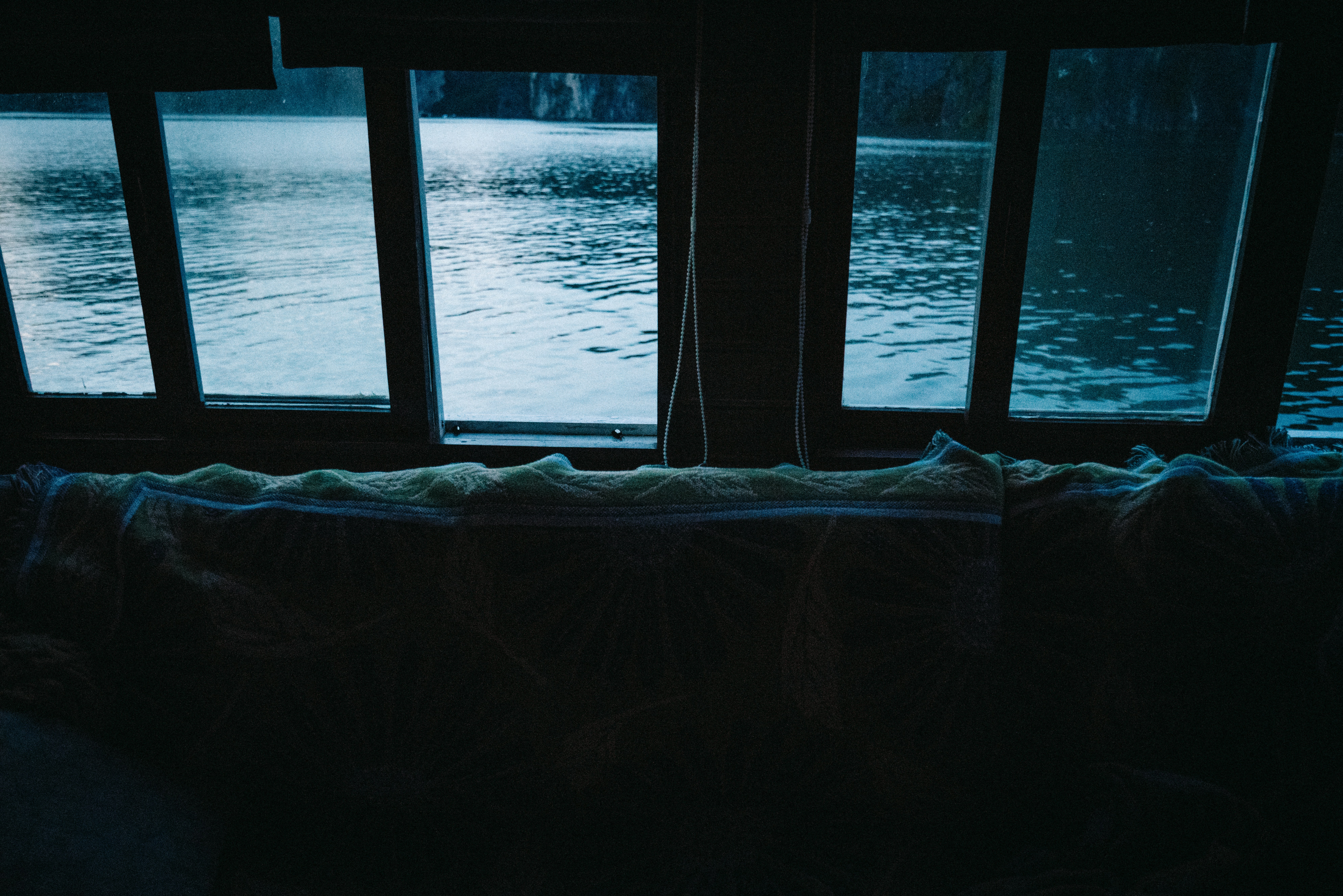 brown wooden window opened near body of water