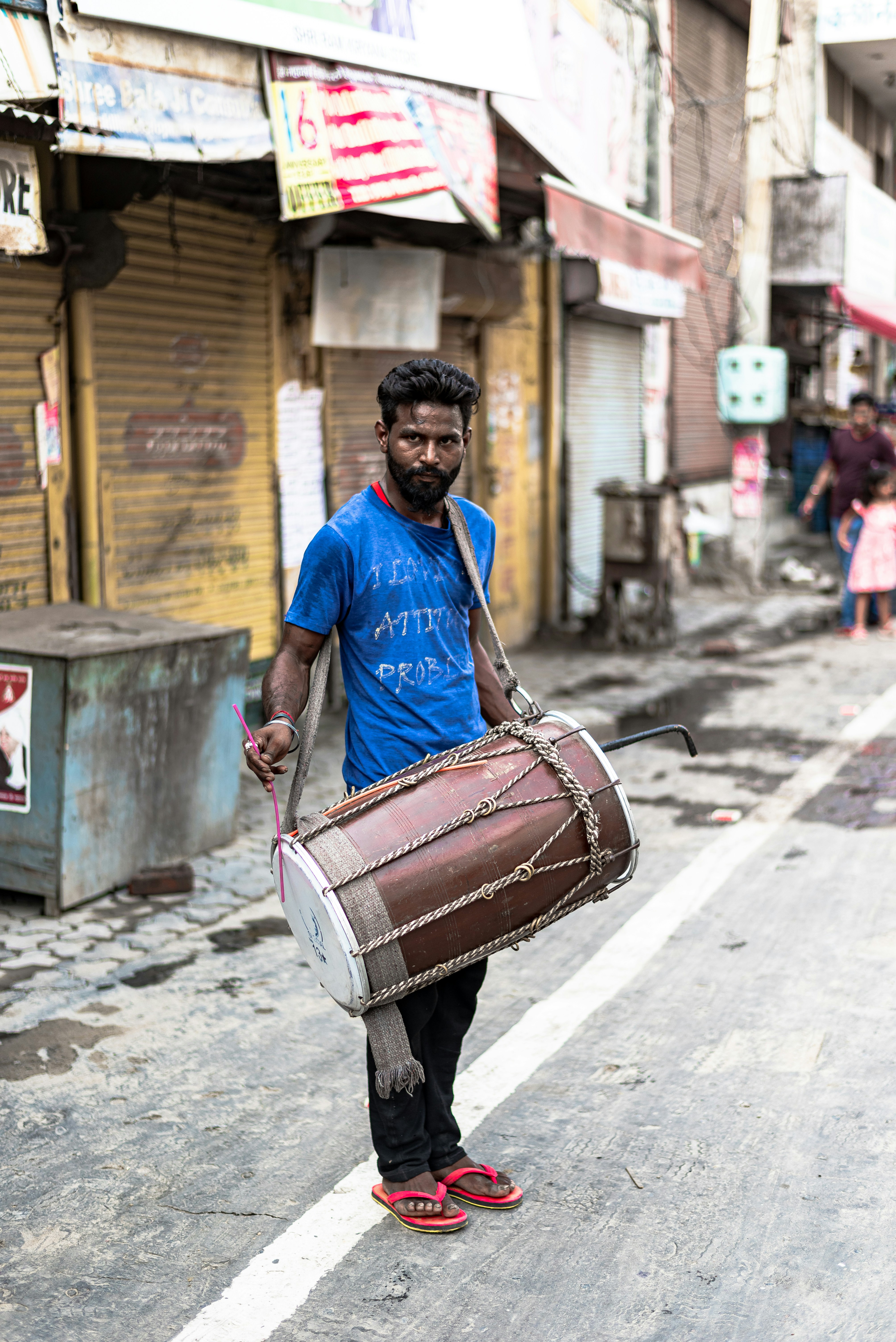Blue-Tee Drummer Anchors a Wet Market Street Beat