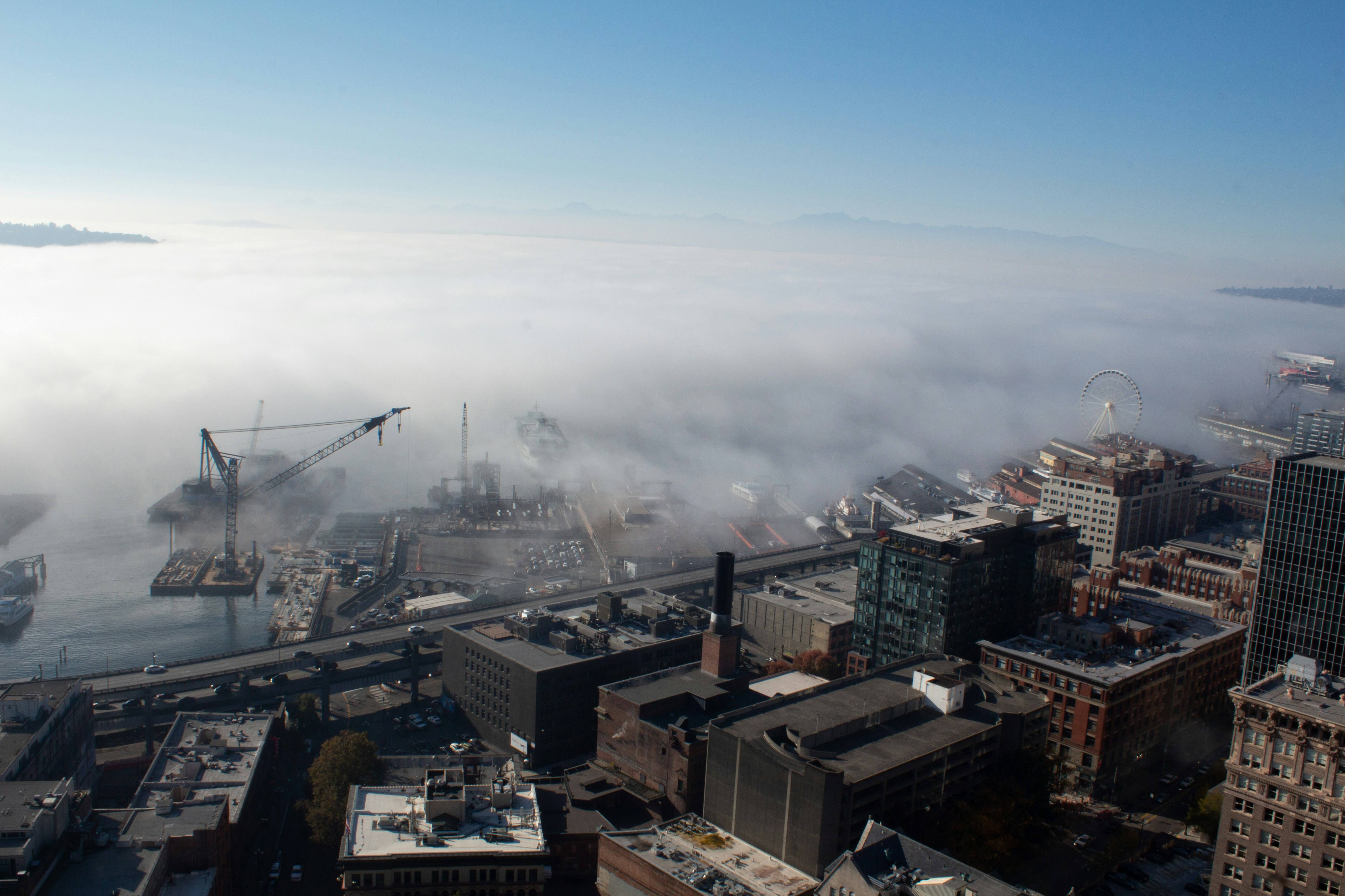 Harbor in the Mist: A Cityscape Crowned by Fog and a Distant Ferris Wheel