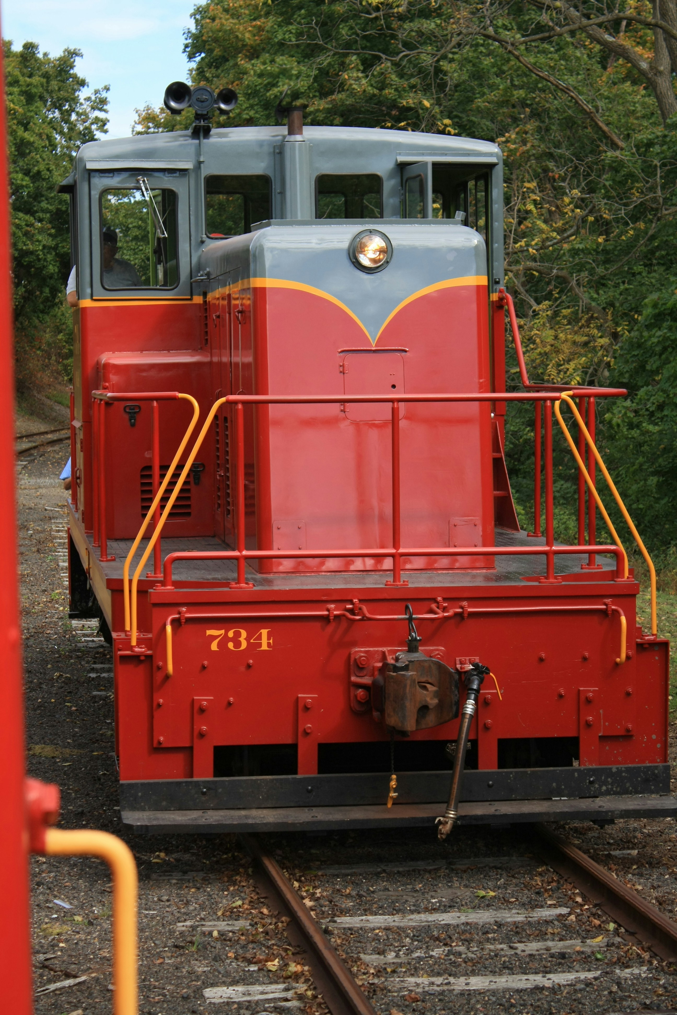 Red and gray train between trees at daytime photo – Free Locomotive ...