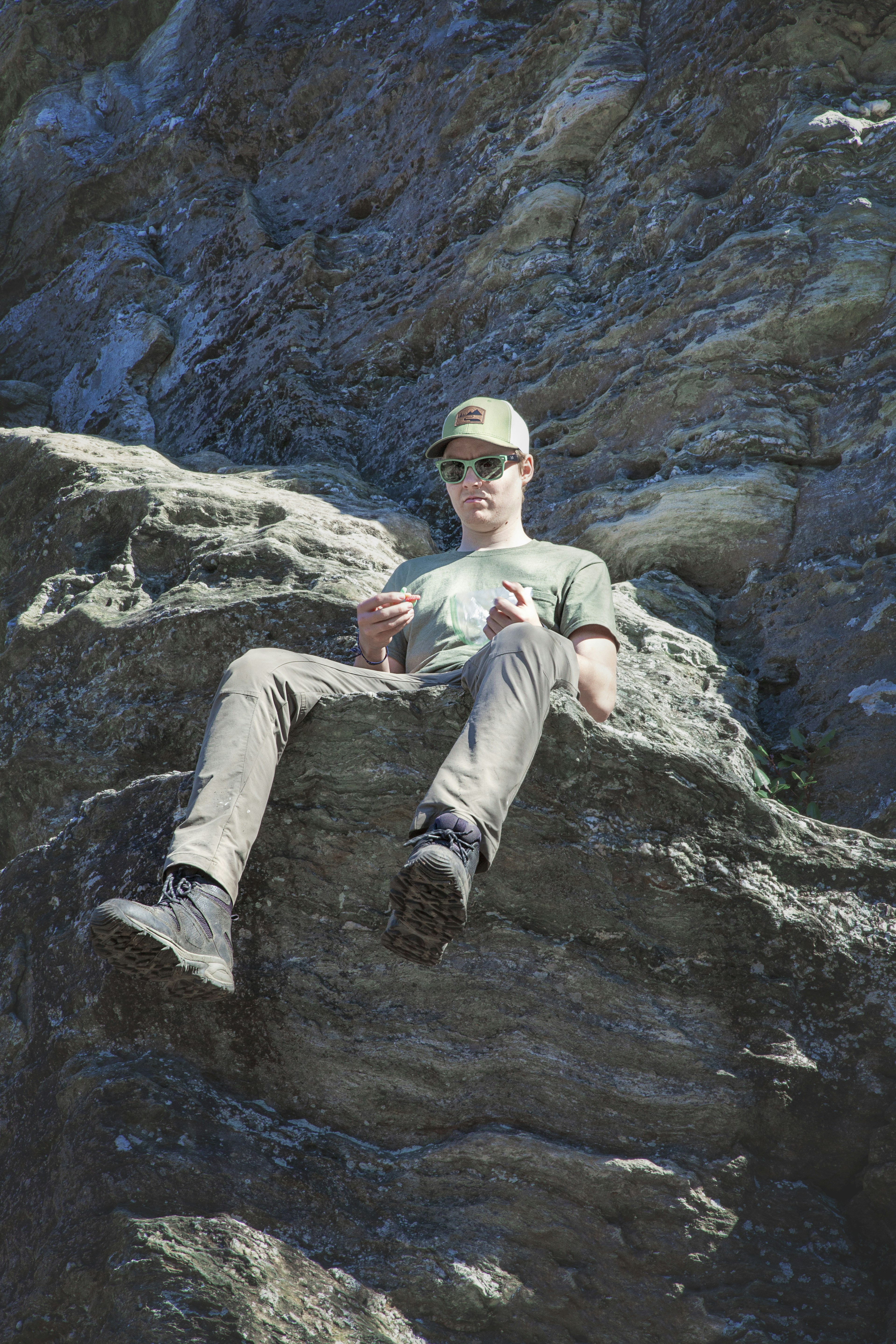 Cliffside Stillness: A lone climber perched on weathered granite