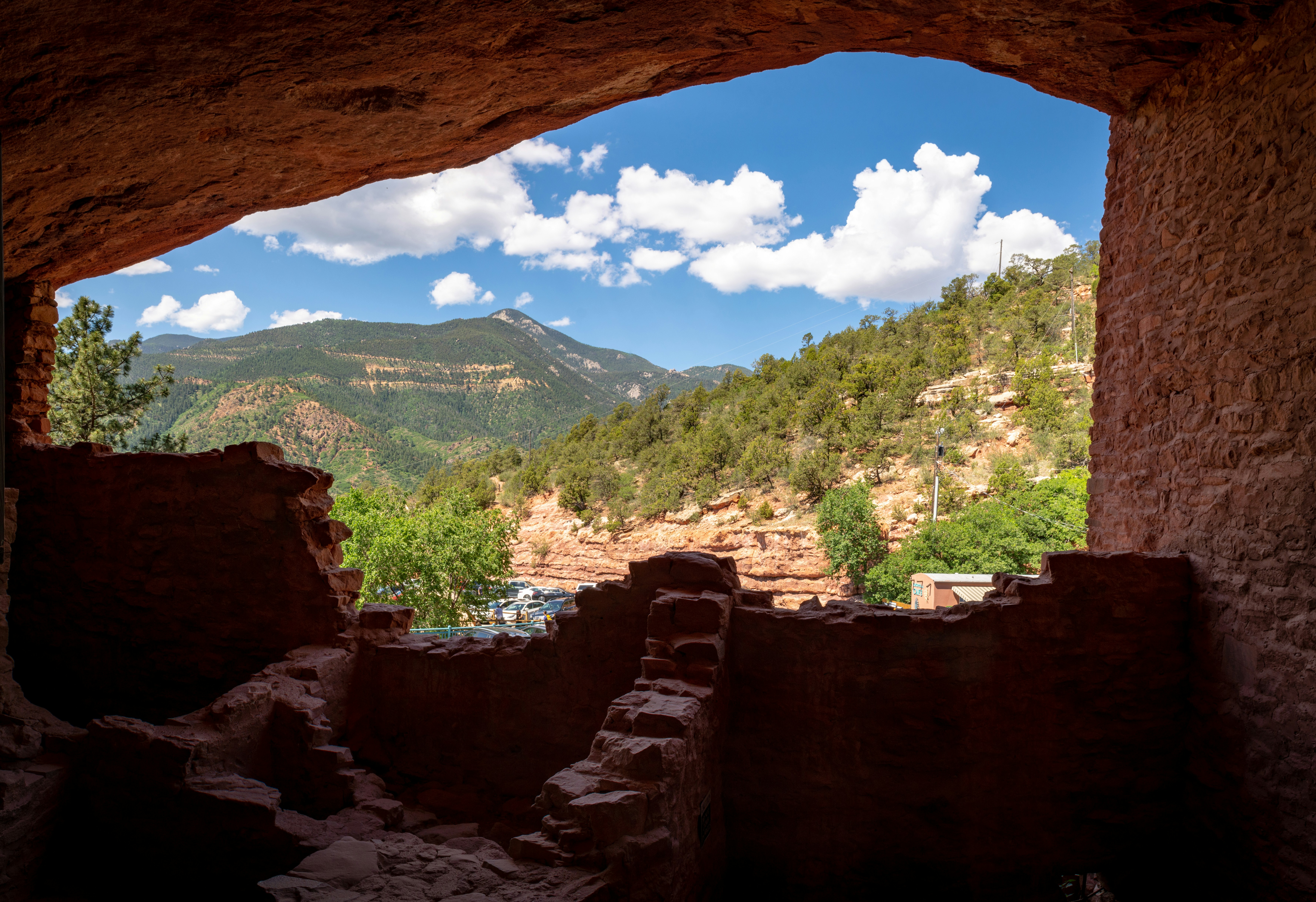 Rim-born Vista: Light on a Valley Framed by a Desert Canyon Arch