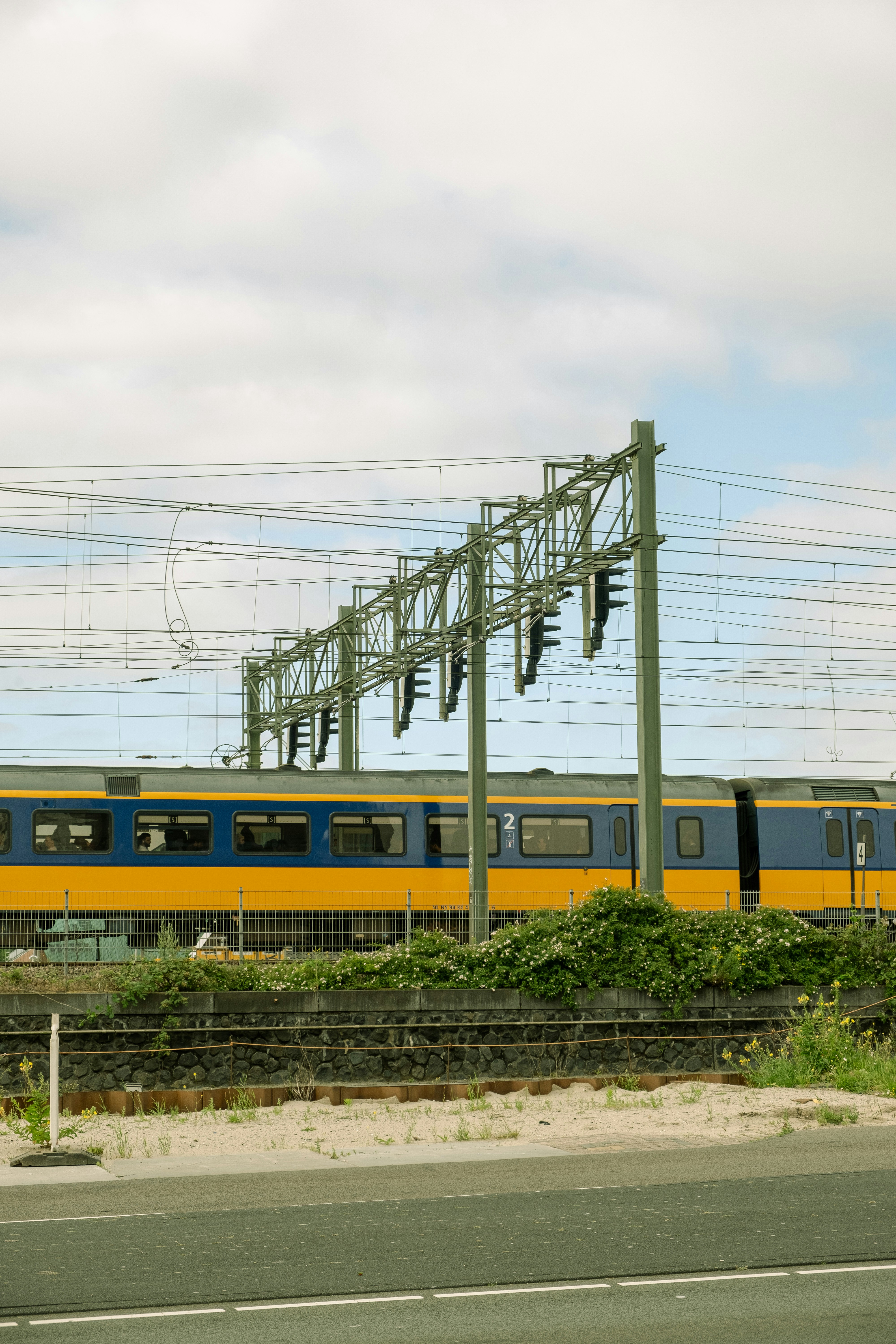 Blue and yellow train under cloudy sky photo – Free Train track Image ...