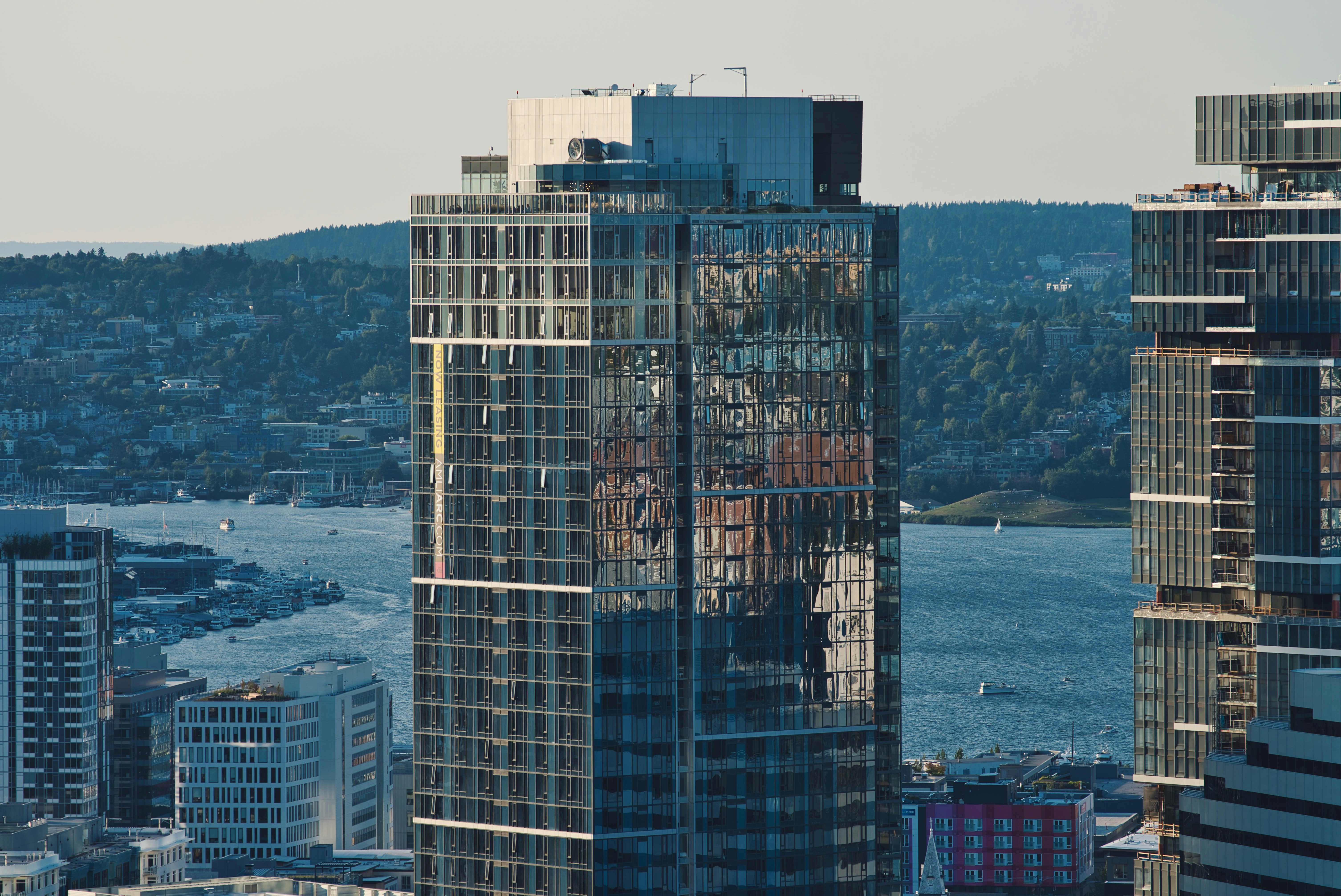 Blue Glass Spine Rising Over a Harbor of Reflections