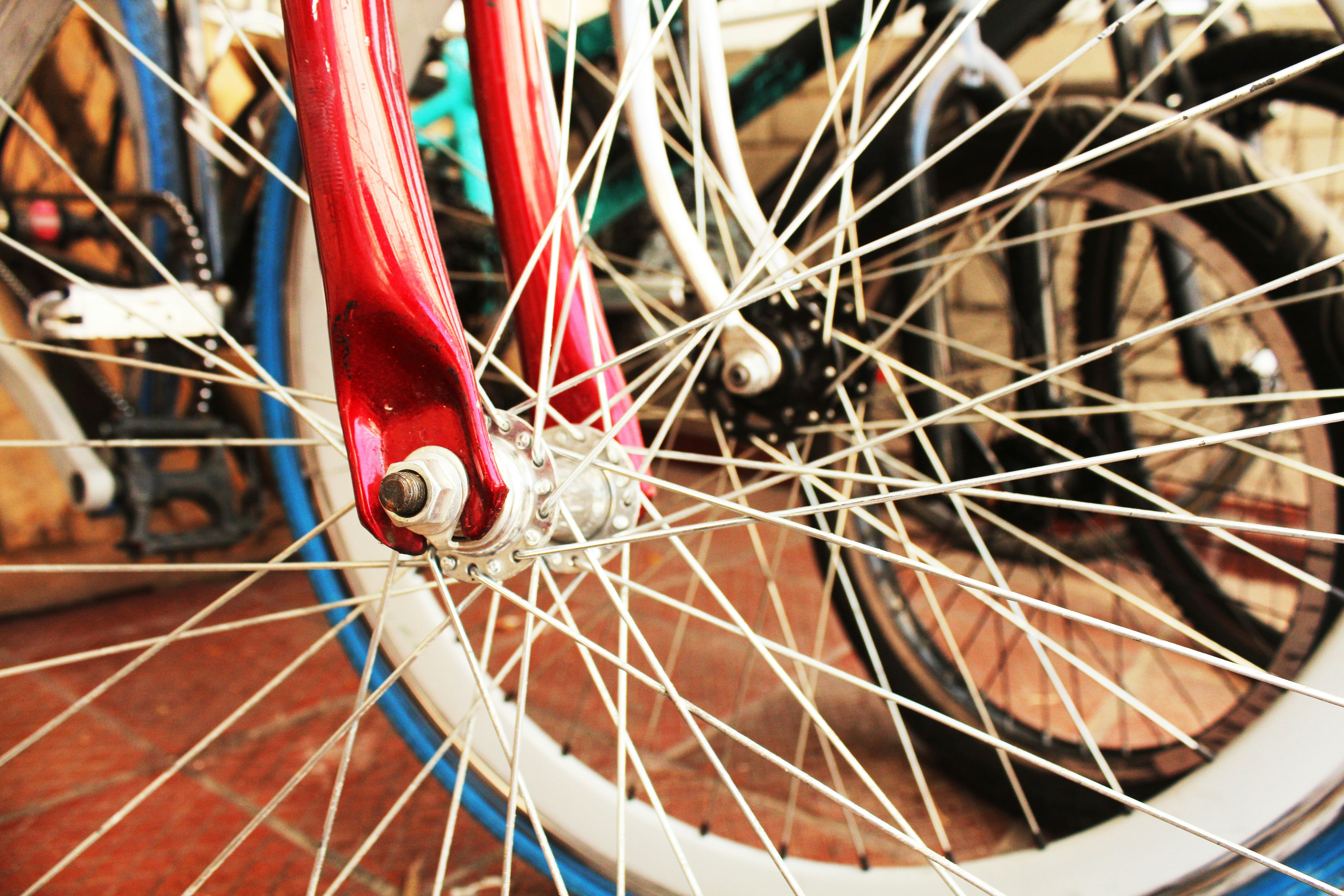 Close-up view of a bicycle's front fork and spokes, showcasing the intricate design and engineering of cycling components.