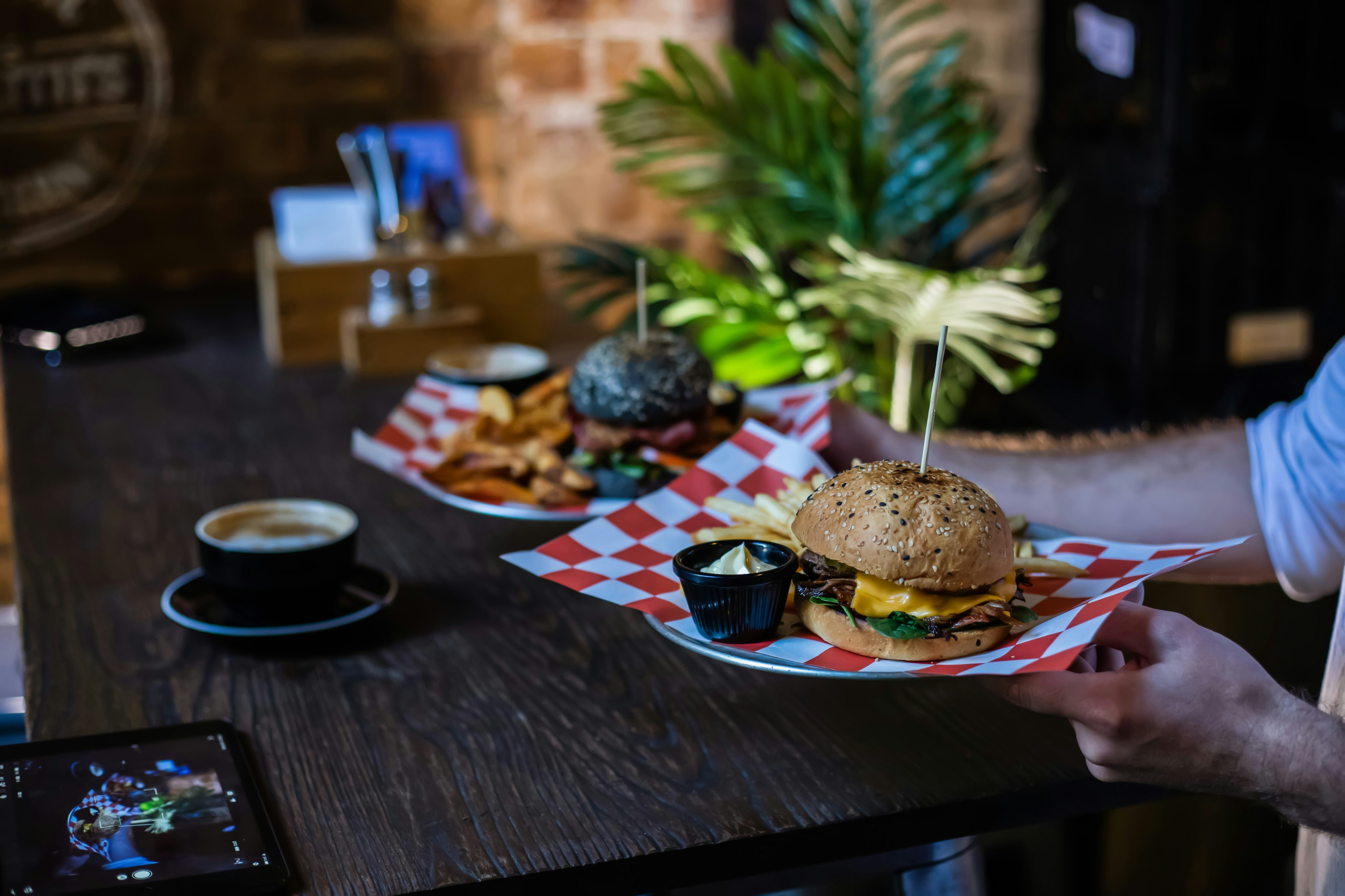 Hand-placed Burger Feast Under Café Lighting