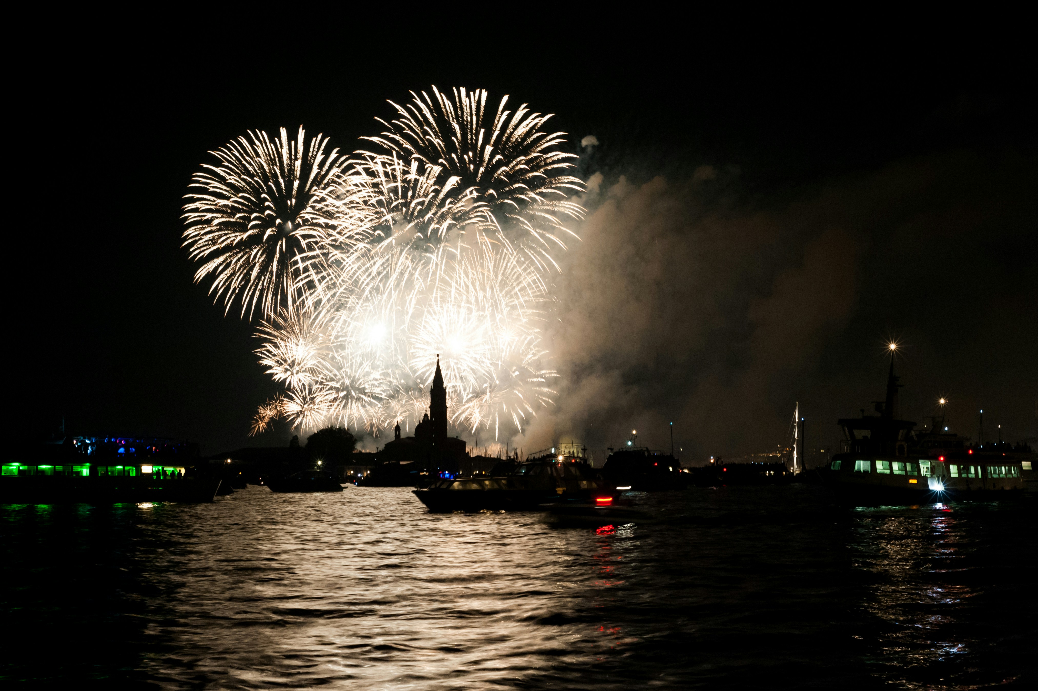 Fireworks over the river: Night display lighting the skyline