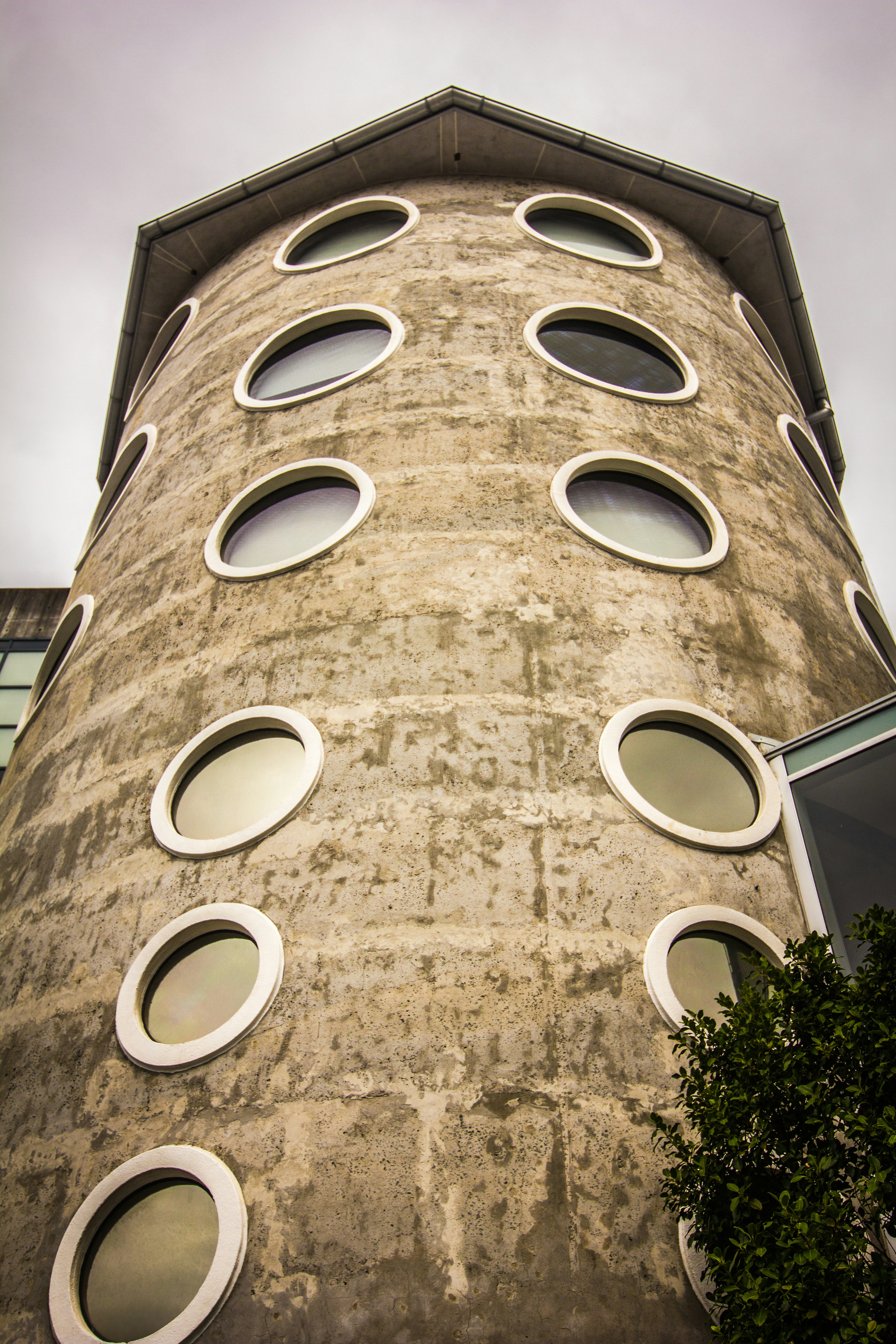 Tower of Ellipses: A Concrete Cylinder Dotted with Round Windows