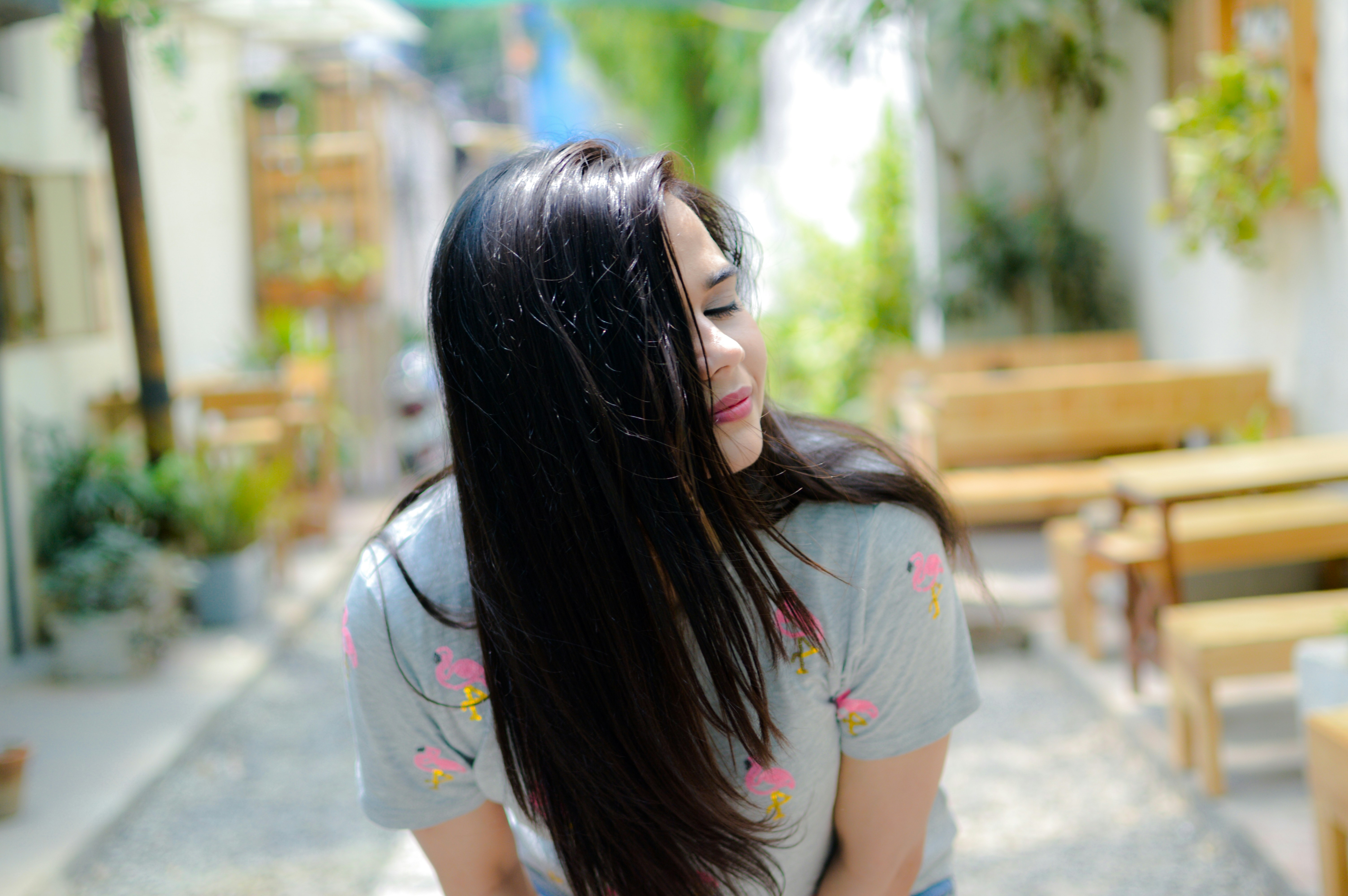 Closed eyed woman leaning forward near benches and tables photo – Free ...