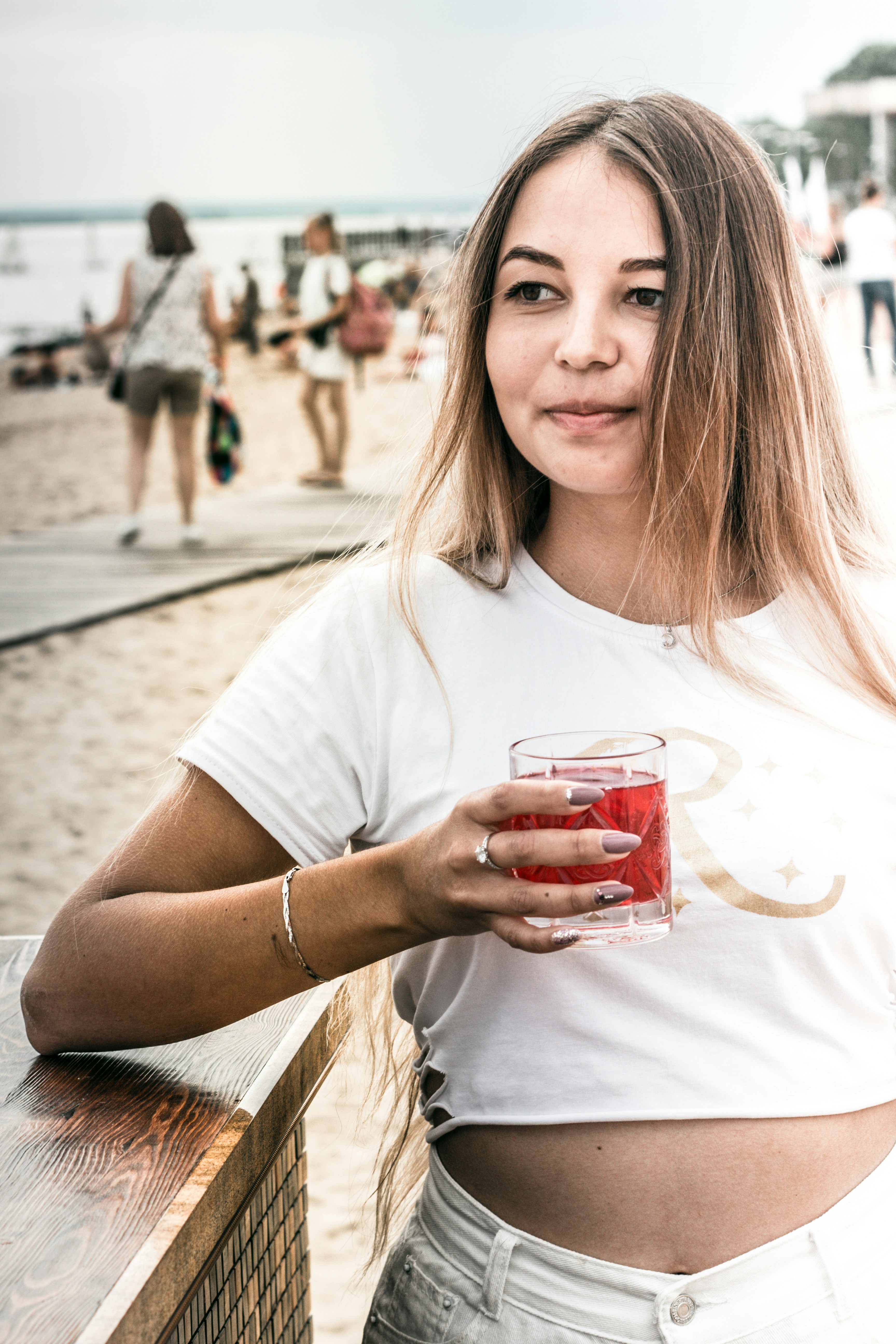 Ruby Sip and Beachside Gaze: A Portrait on the Boardwalk