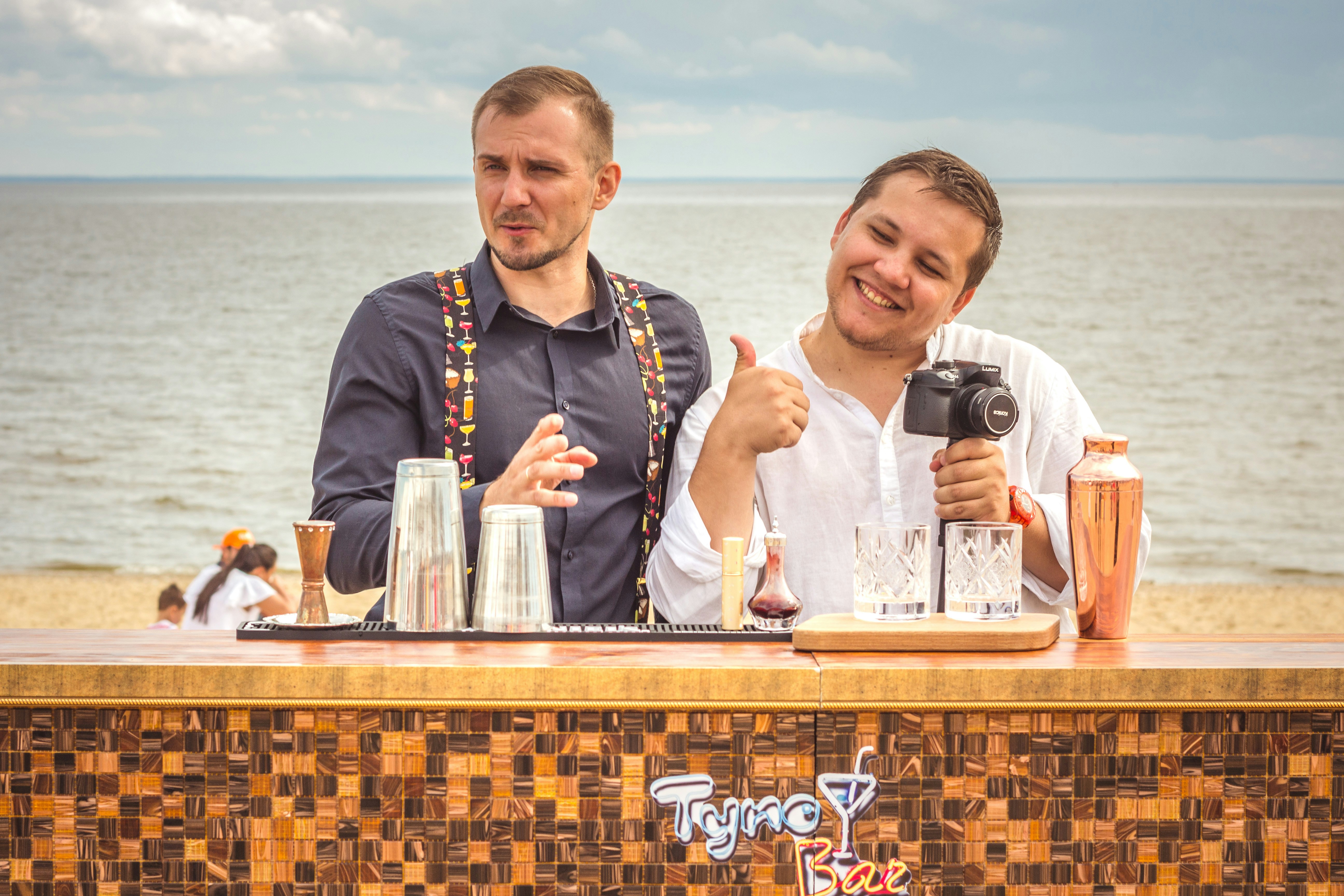 Thumbs Up at the Tiled Seaside Bar: A Candid Beach Moment