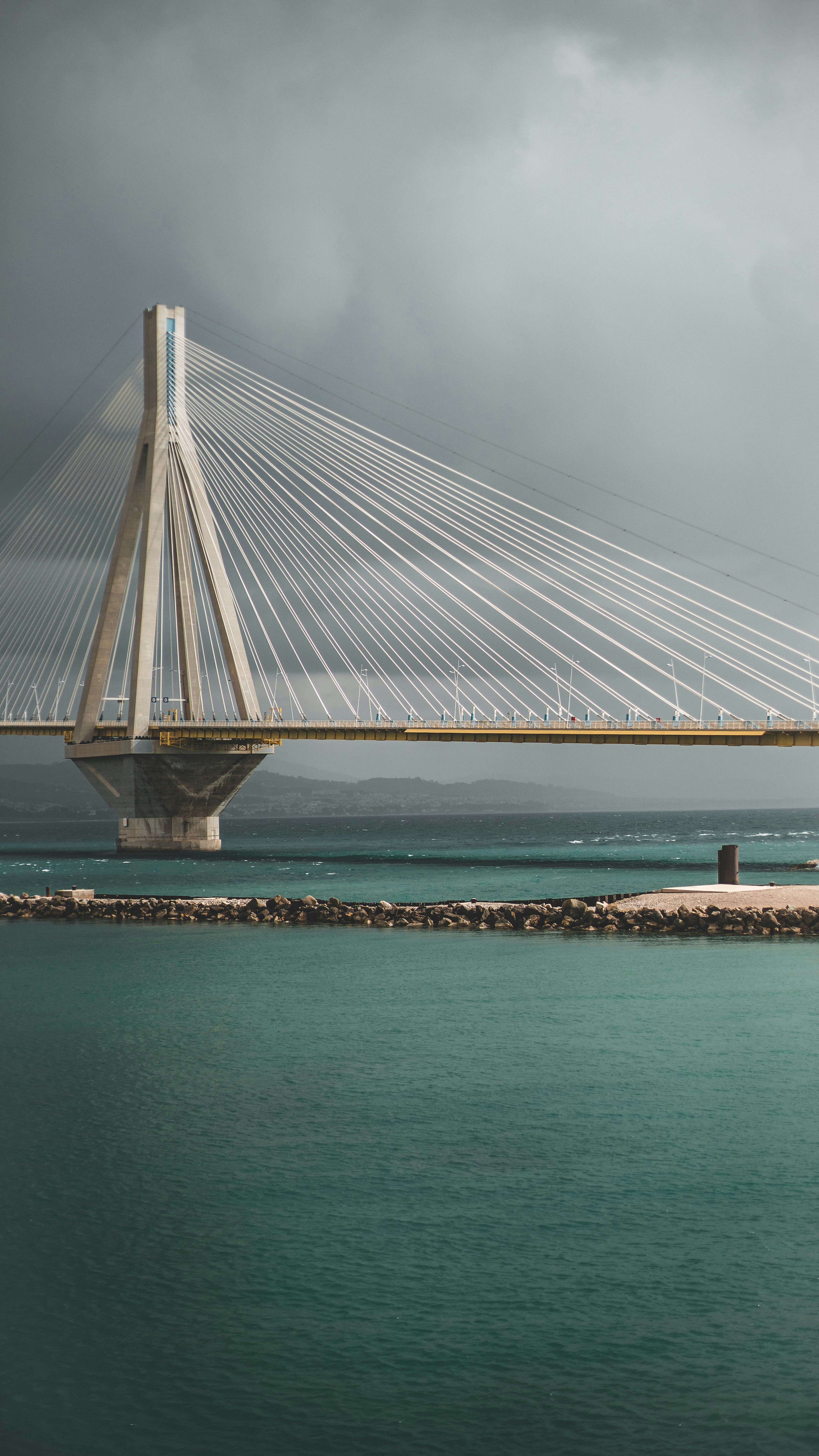 A large bridge spanning over a body of water photo – Free Wallpaper ...