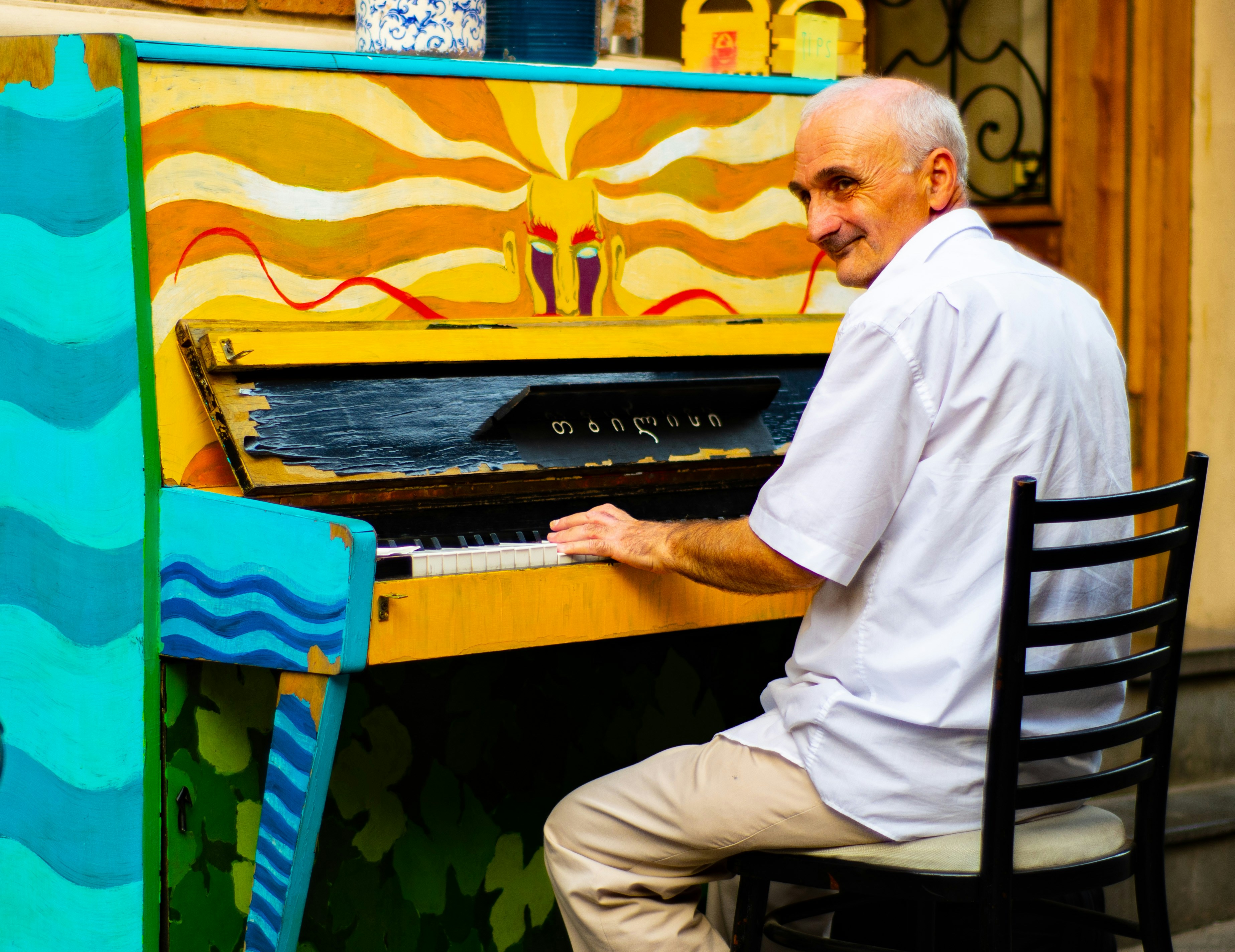 Bright Street Serenade: The Piano Mann in a Painted Oasis