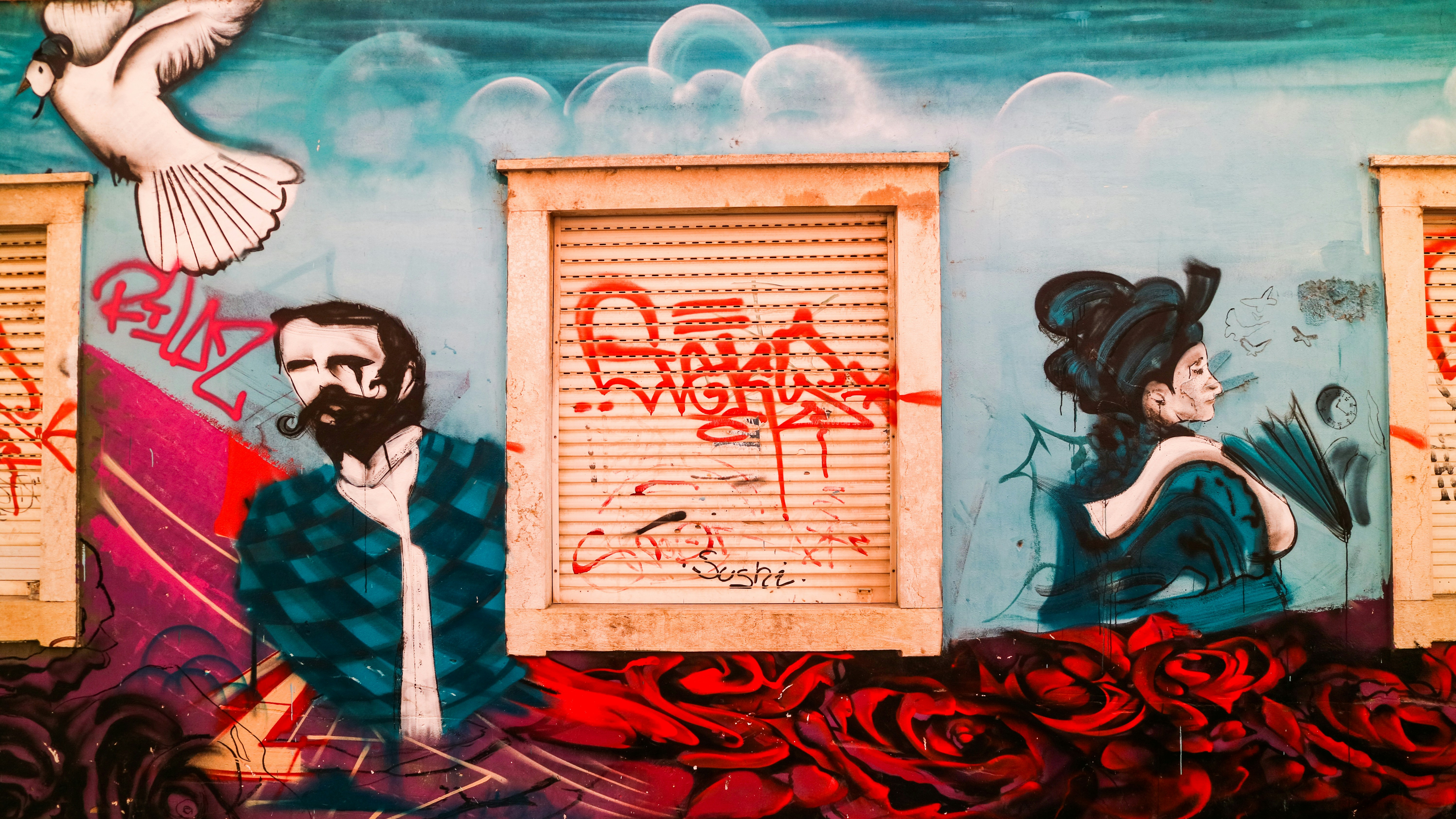 Man and woman wearing traditional tops graffiti between windows photo ...