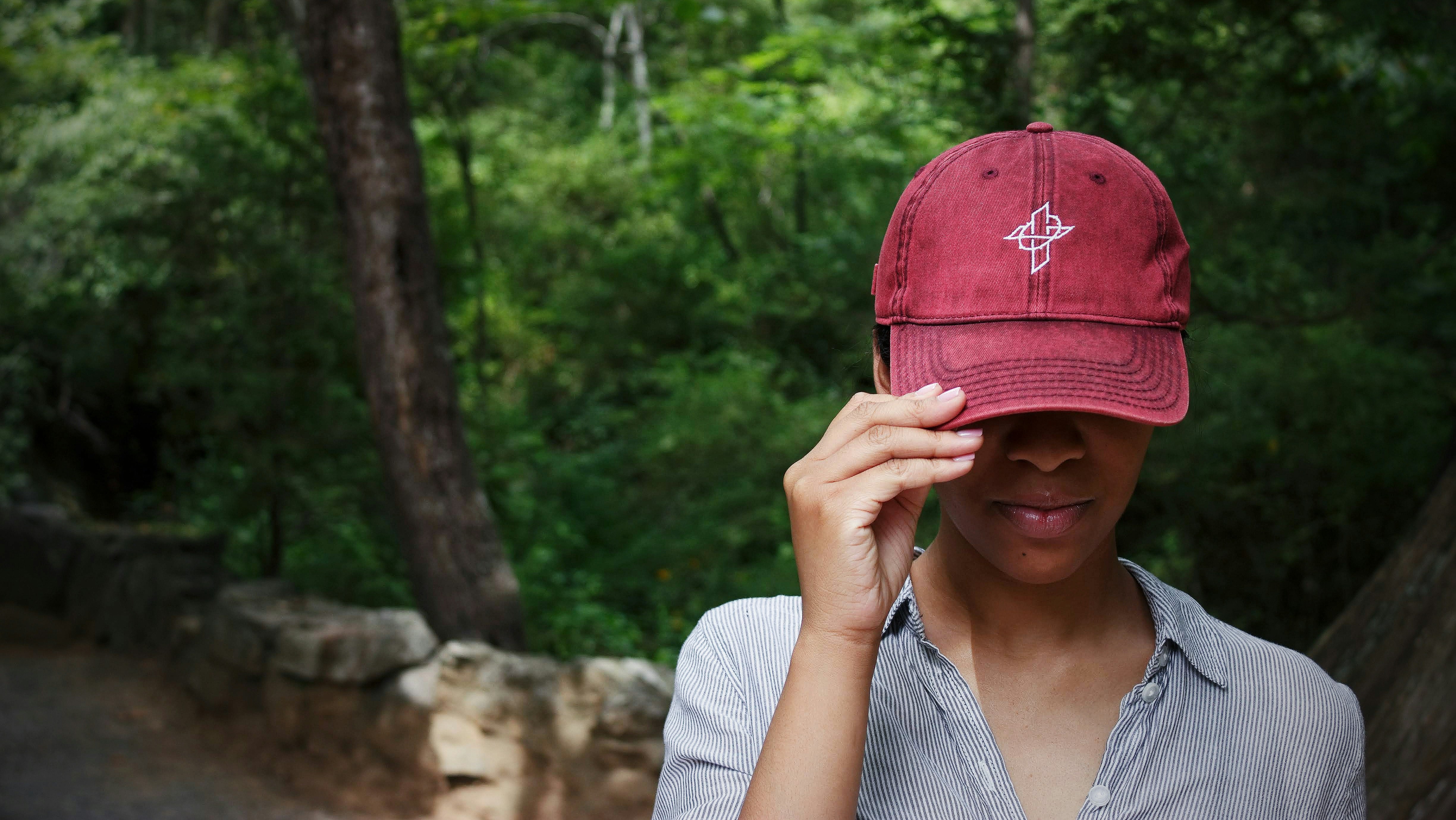 Man wearing and holding fitted cap photo – Free Apparel Image on Unsplash