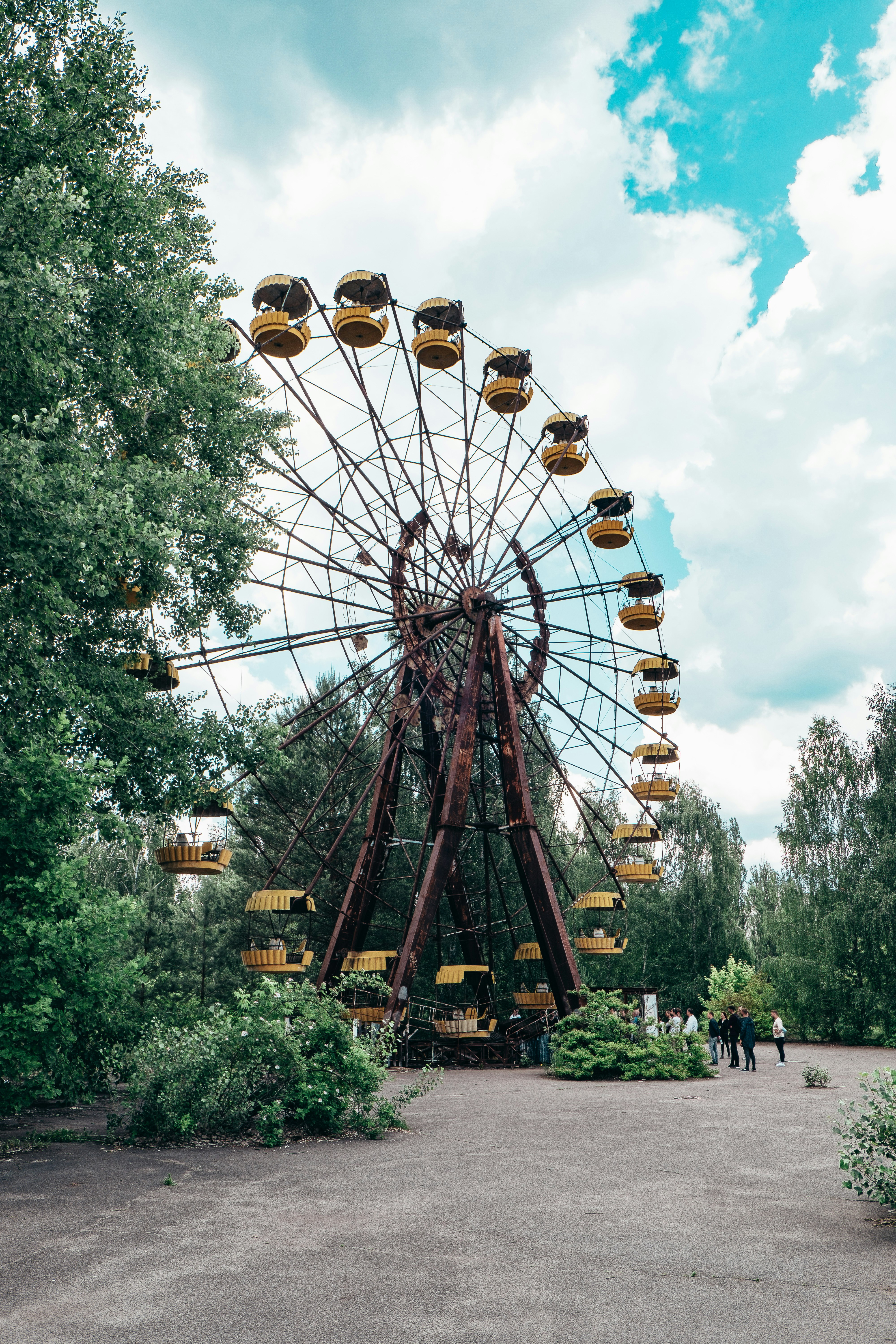 yellow and brown ferris wheel under white clouds