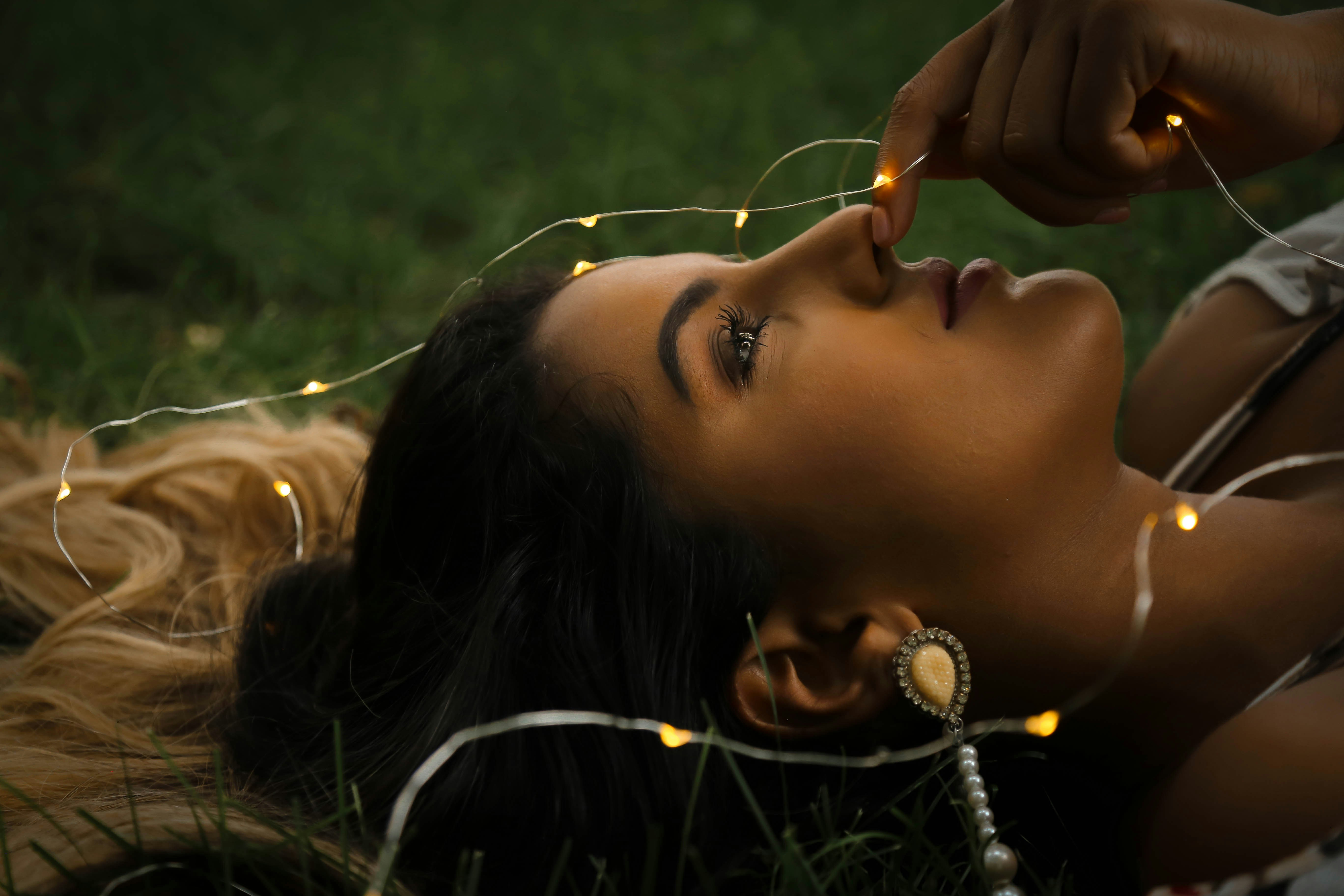 Glow in the Grass: A Luminous Portrait Amid Fairy Lights