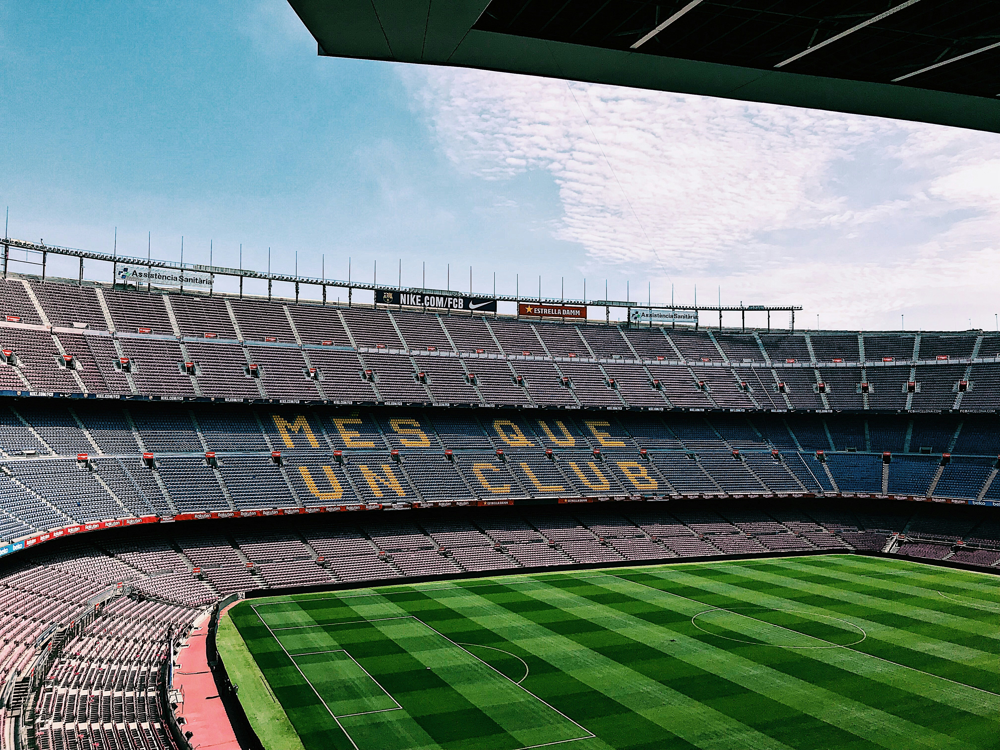 Symmetrical Stadium Expanse: Green Pitch Under a Quiet Sky