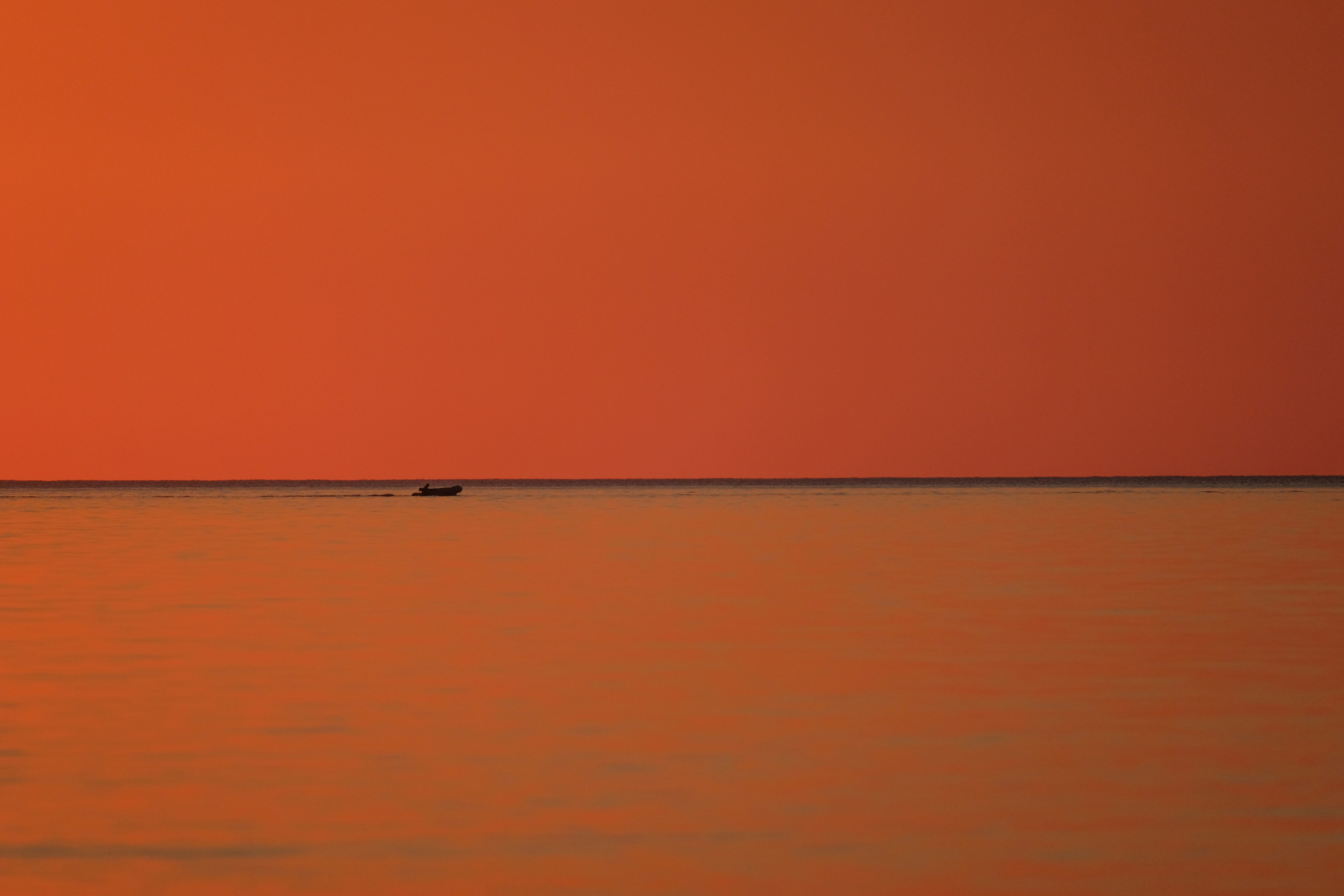 Ember Horizon: A Quiet Boat on the Tangerine Sea
