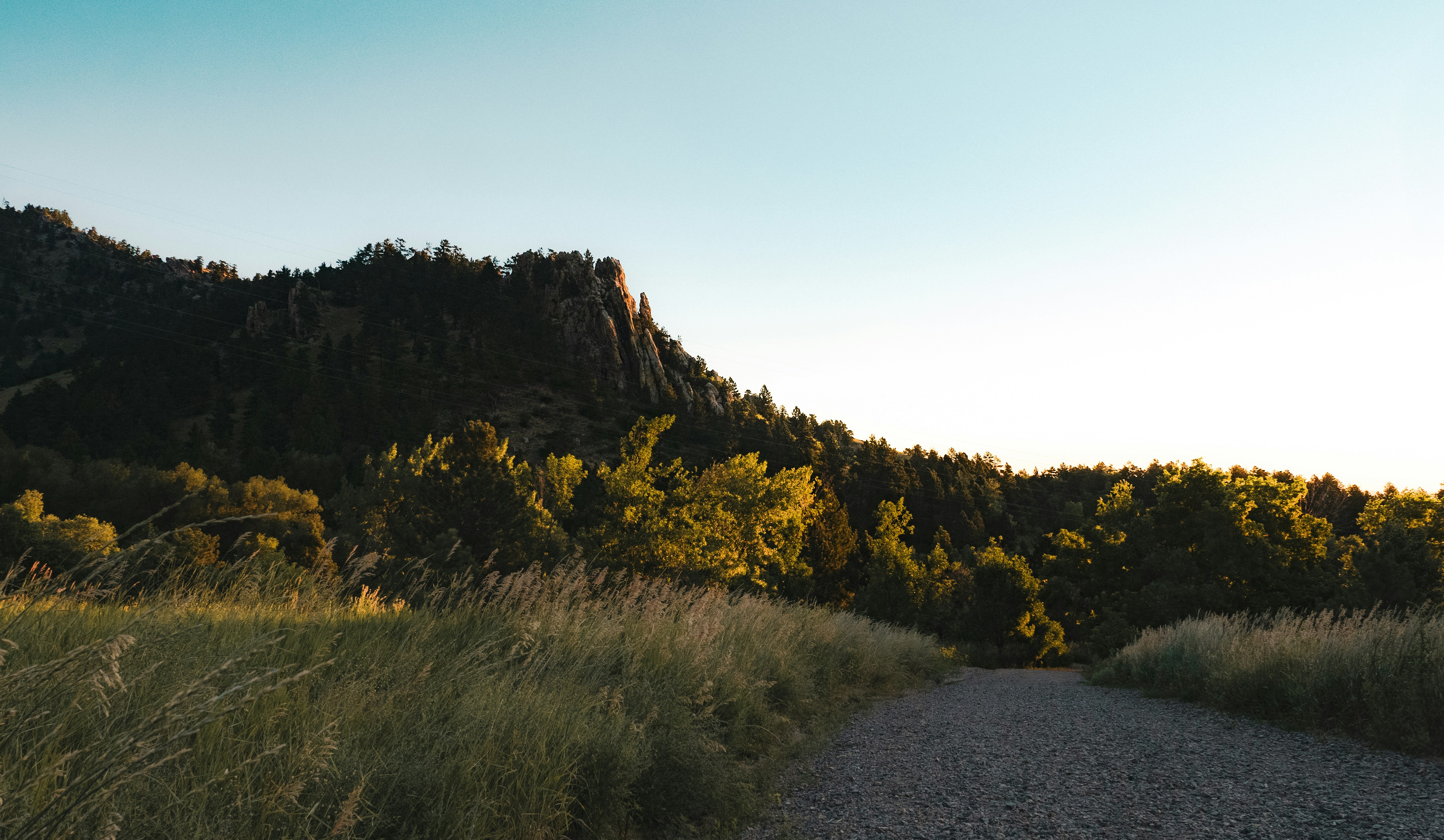 Sunlit Ridge along a Quiet Gravel Path at Golden Hour