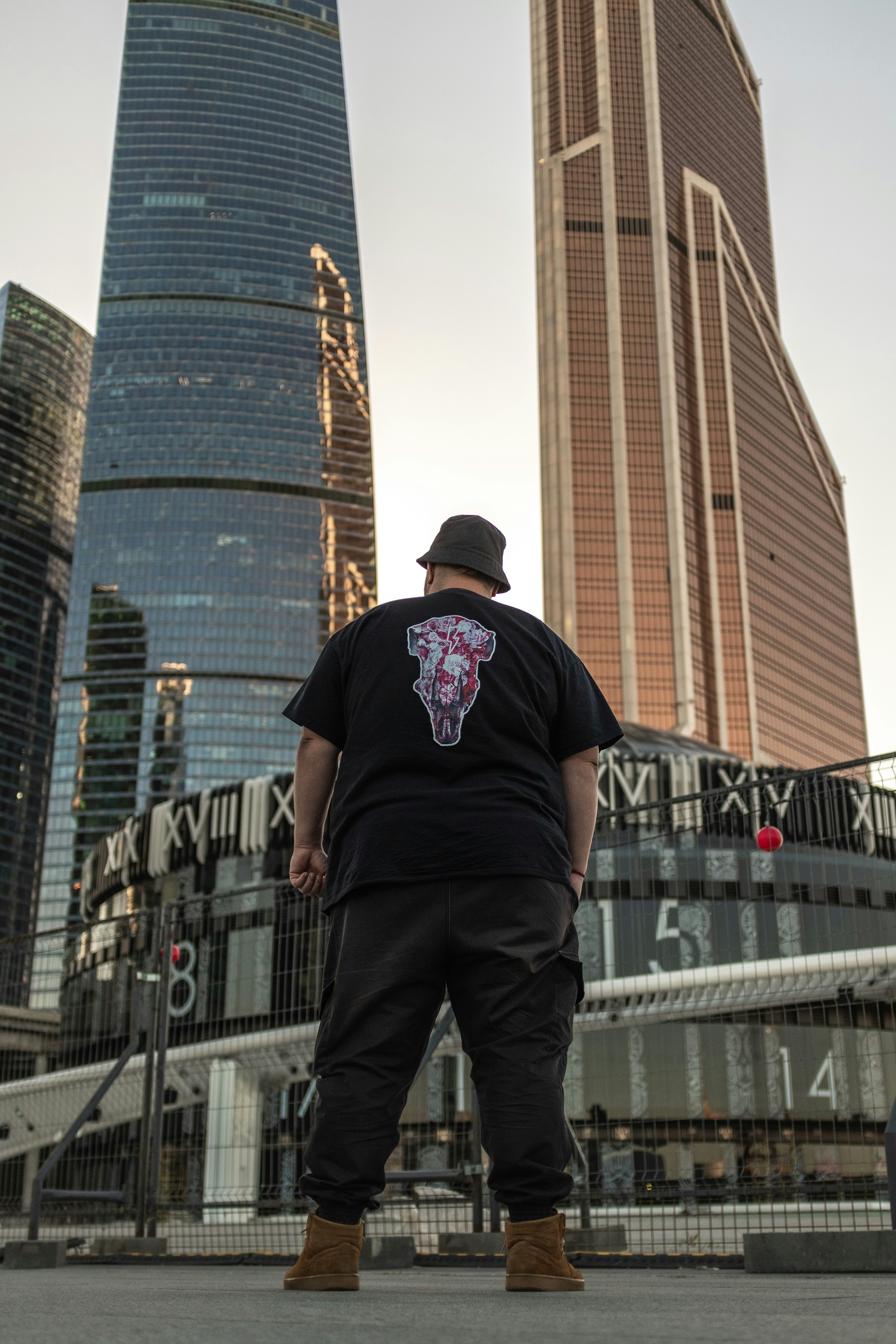 Man standing in front of high-rise glass buildings photo – Free Boat ...