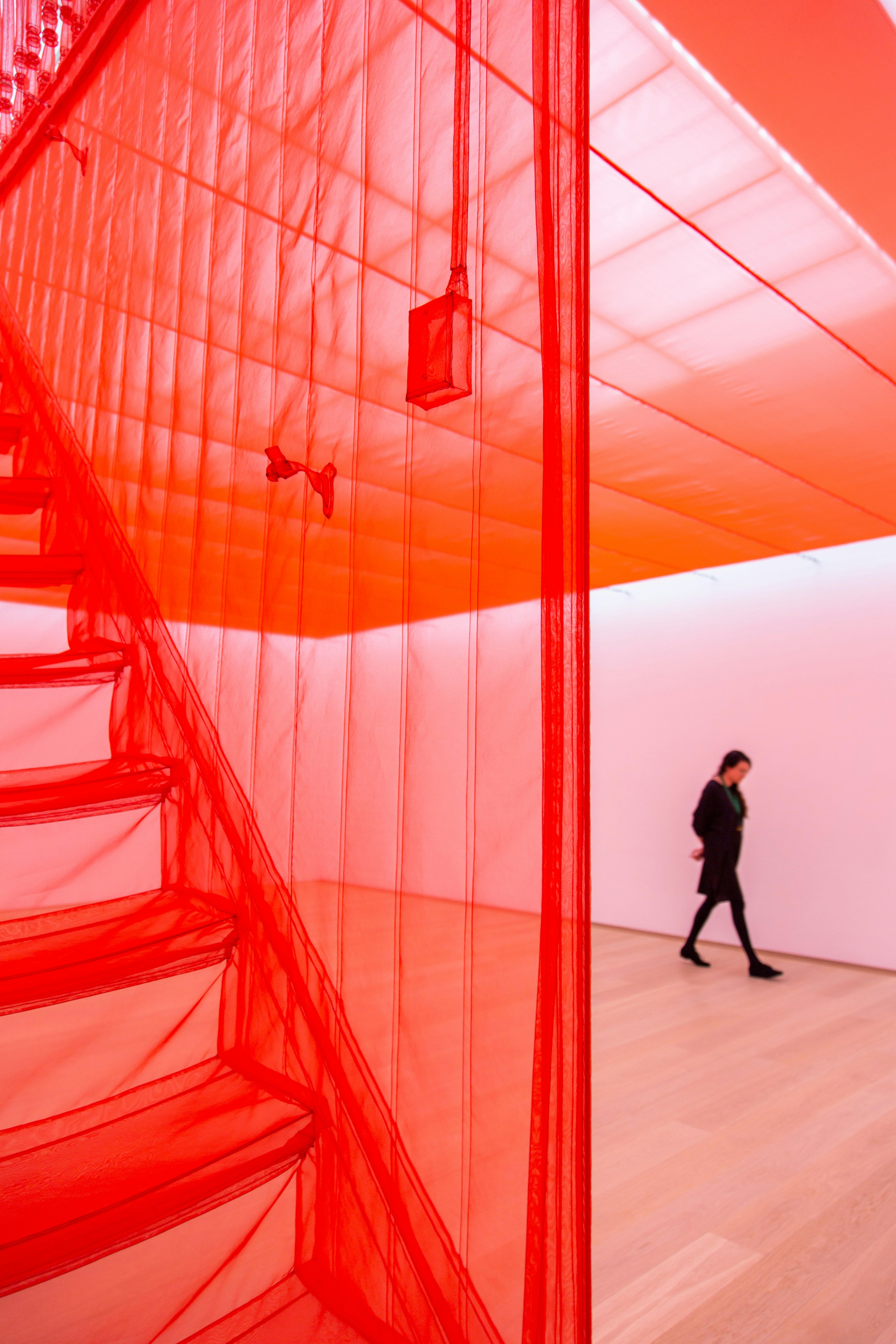 Person walking inside room photo – Free Red Image on Unsplash