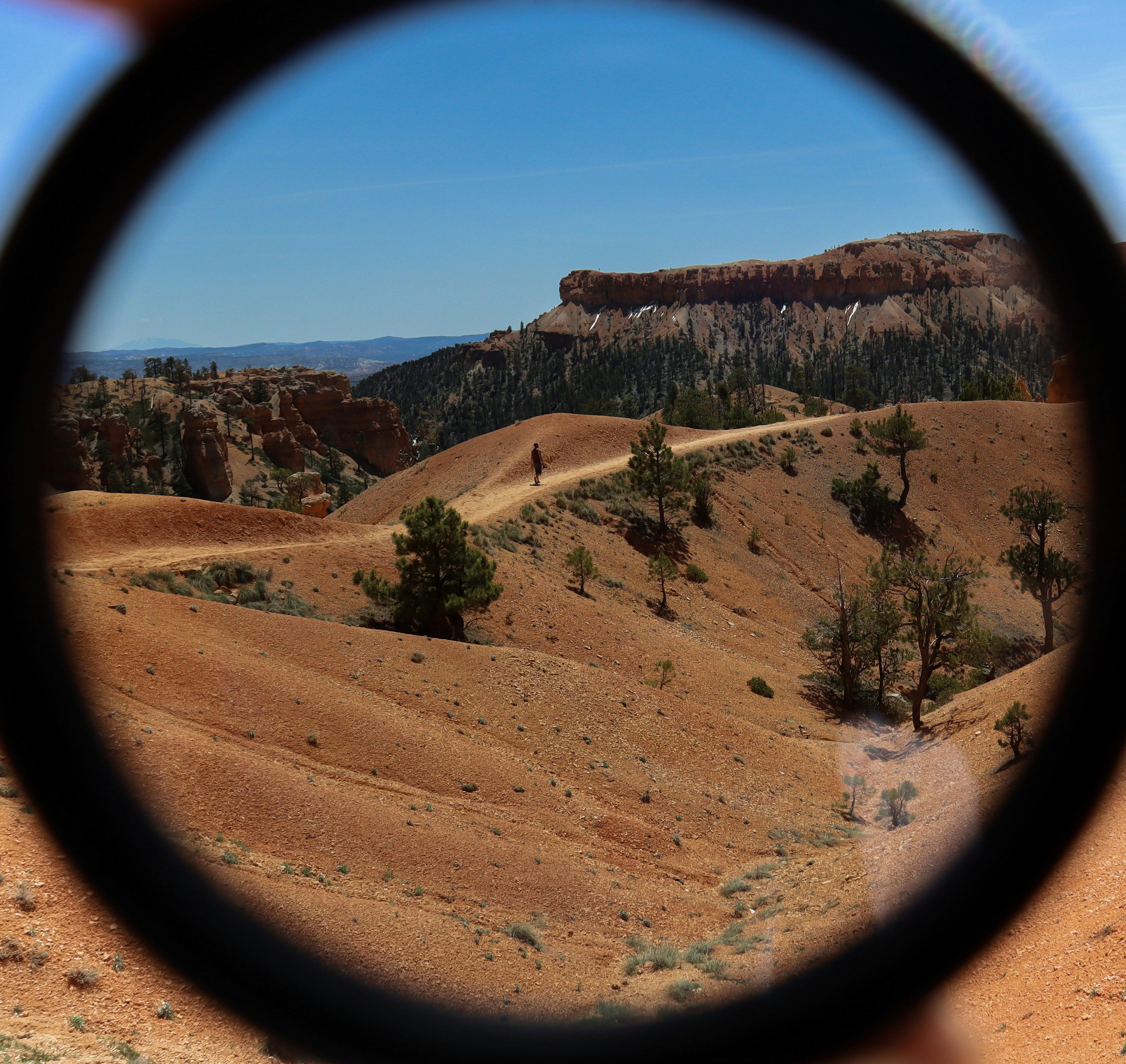 Ridge Walk Through Red Canyon Framed by a Circular Viewfinder