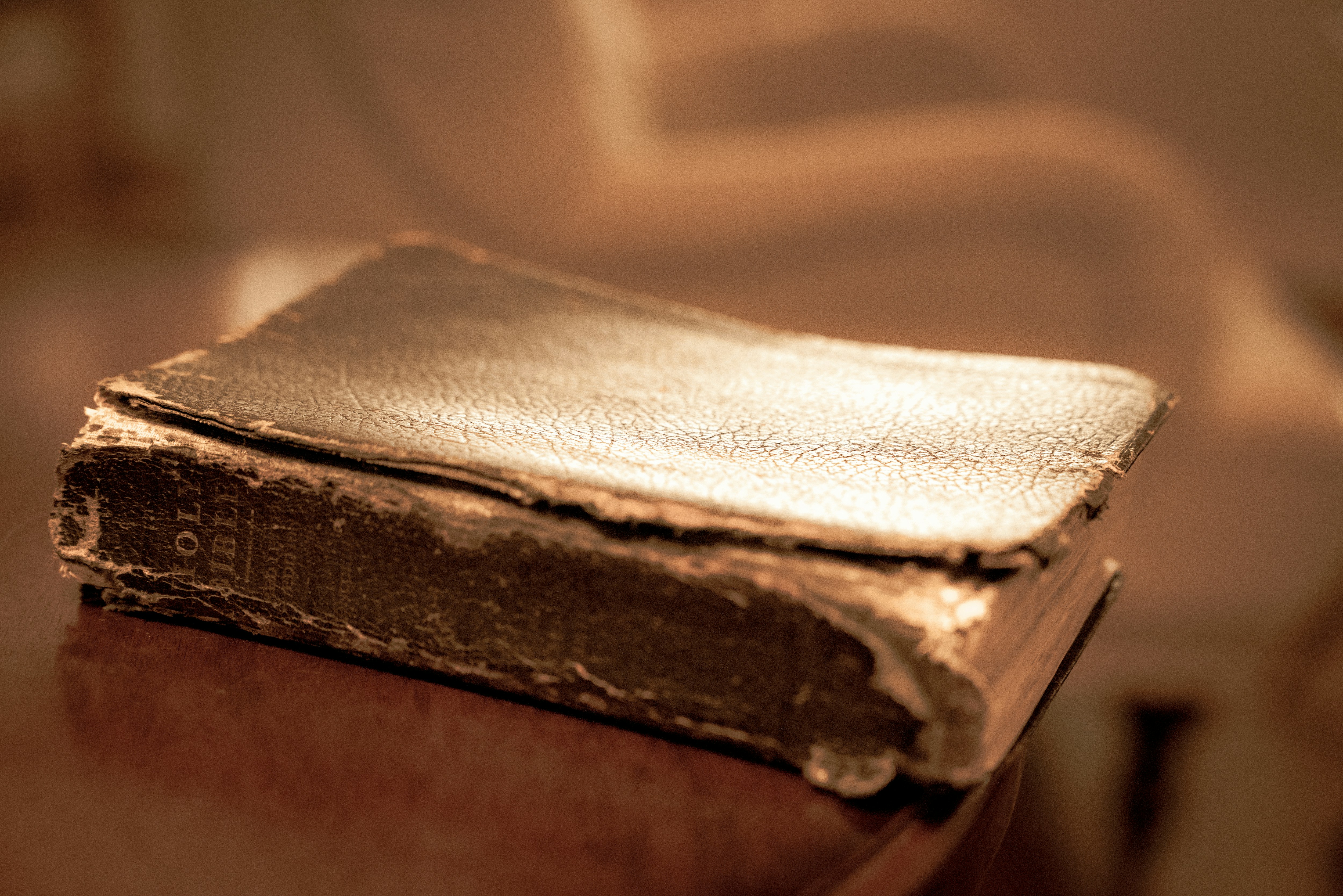 Weathered Tome Under a Warm Sepia Glow on a Quiet Desk