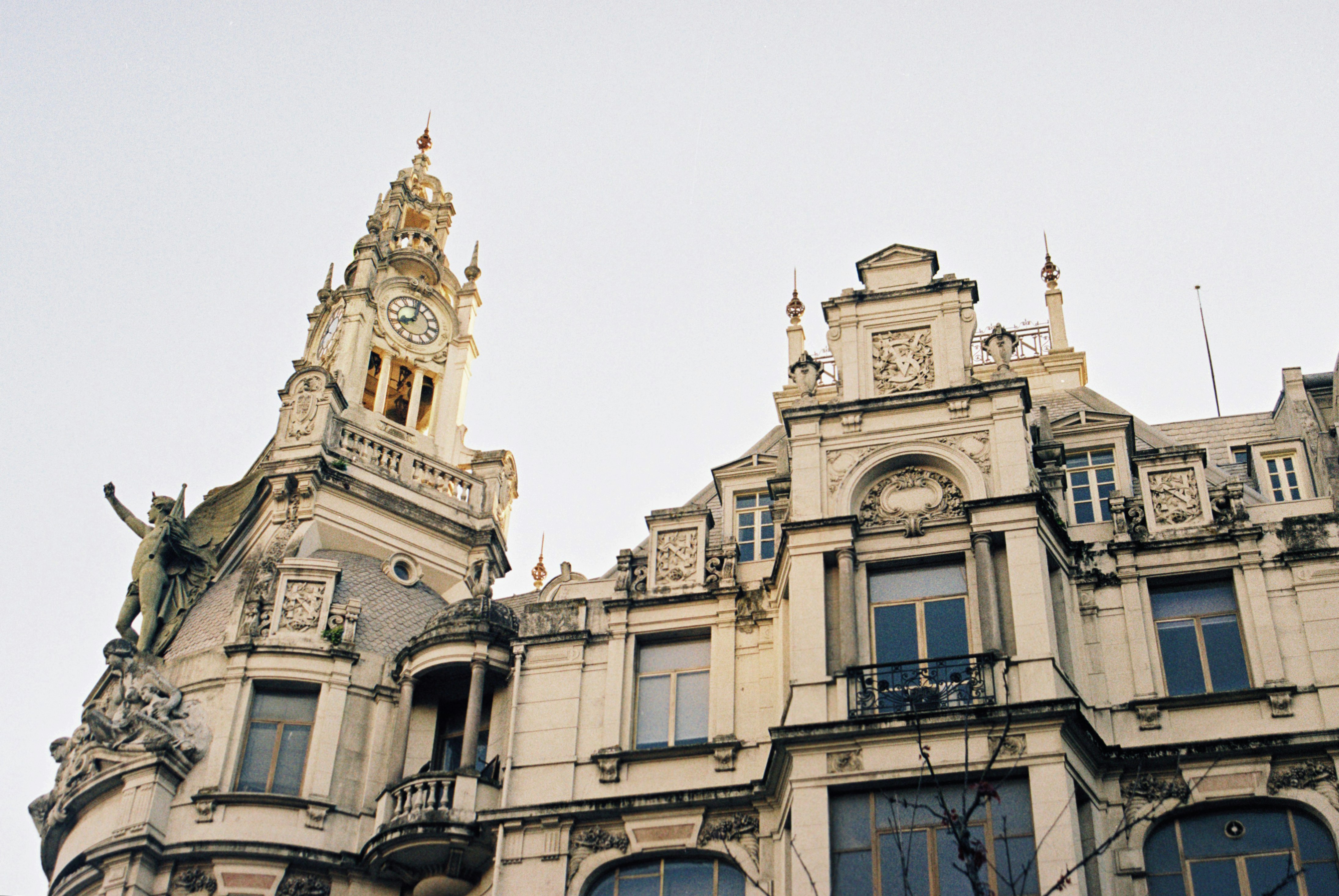 Historic building featuring ornate details and a prominent clock tower, showcasing classic architectural design elements.