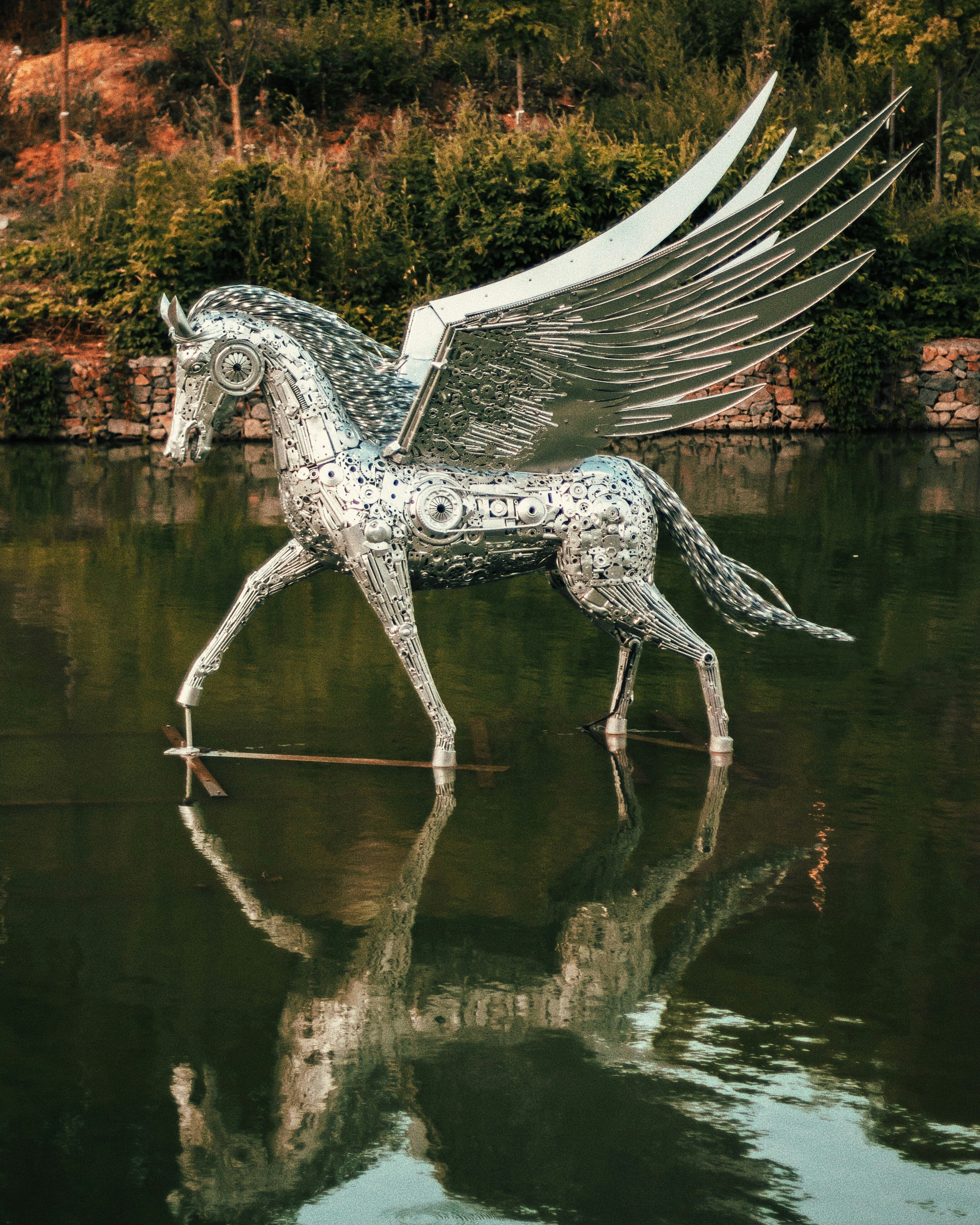 Shimmering Steel Pegasus on a Quiet Lake