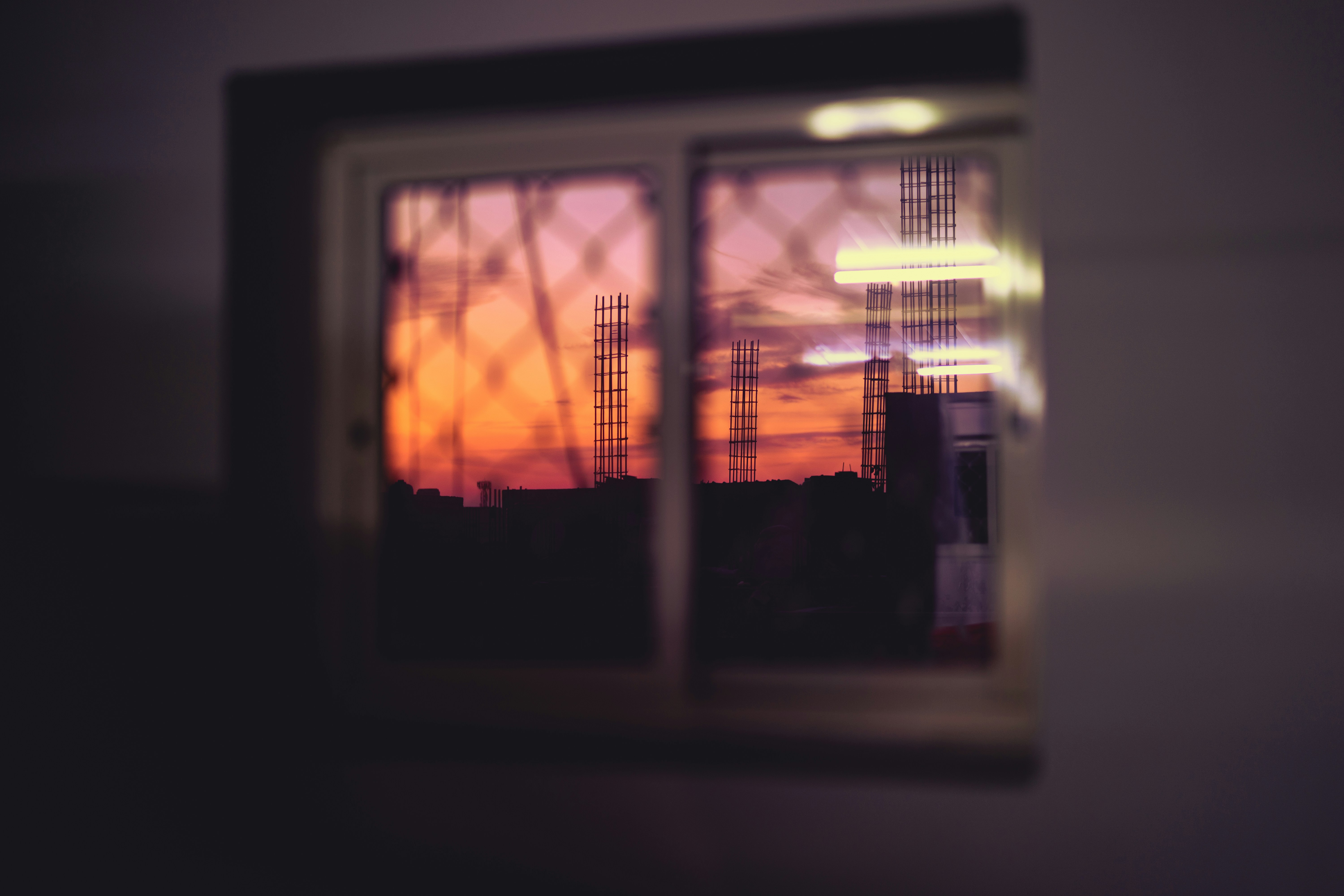Window overlooking black towers during golden hour photo – Free Window ...