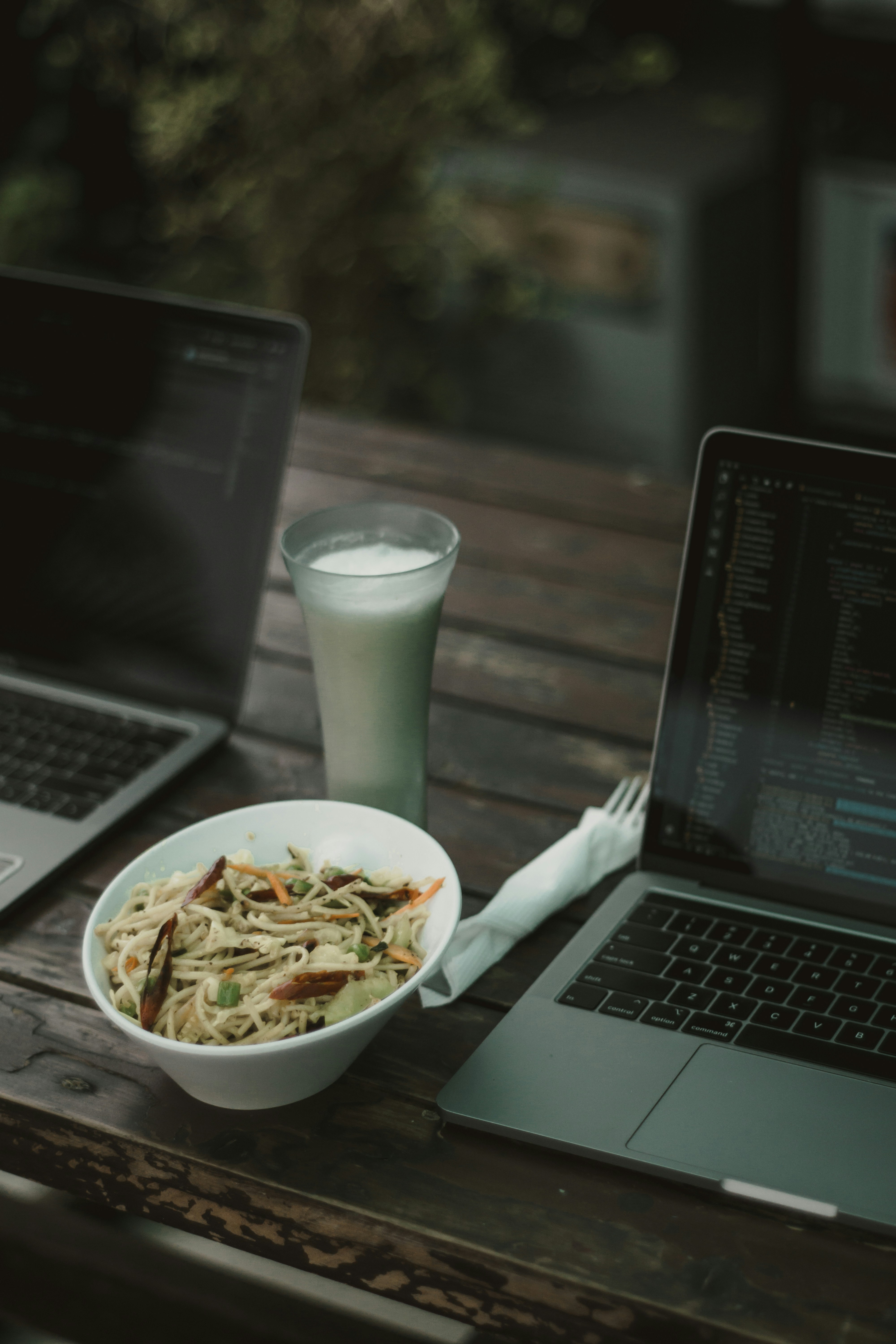 Pasta Break Between Screens on a Weathered Outdoor Desk