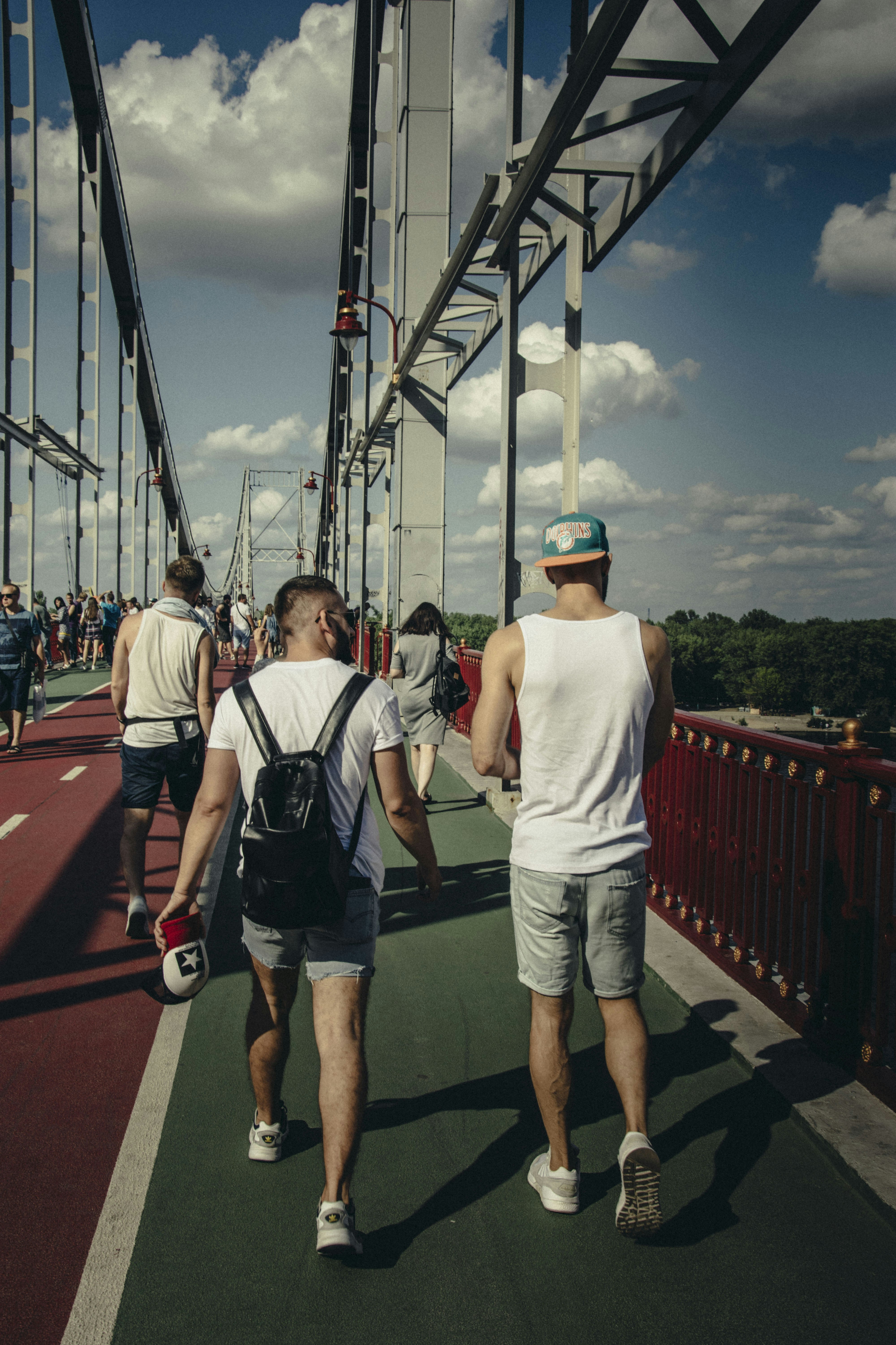 Stride on the Suspension Bridge: Sunlit Figures on a Steel Walkway