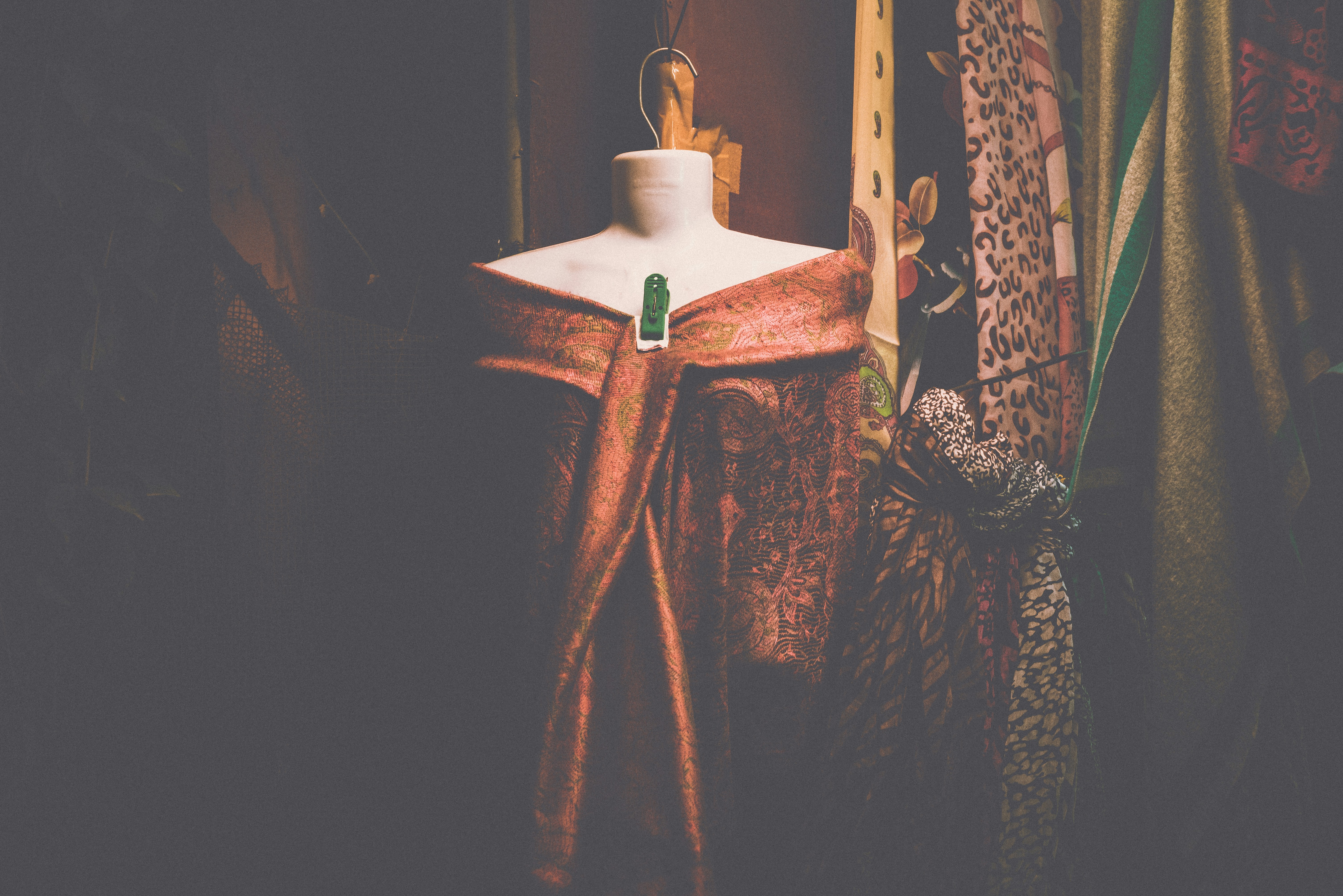 Velvet Spotlight: Burgundy Dress on a Dim Boutique Stage