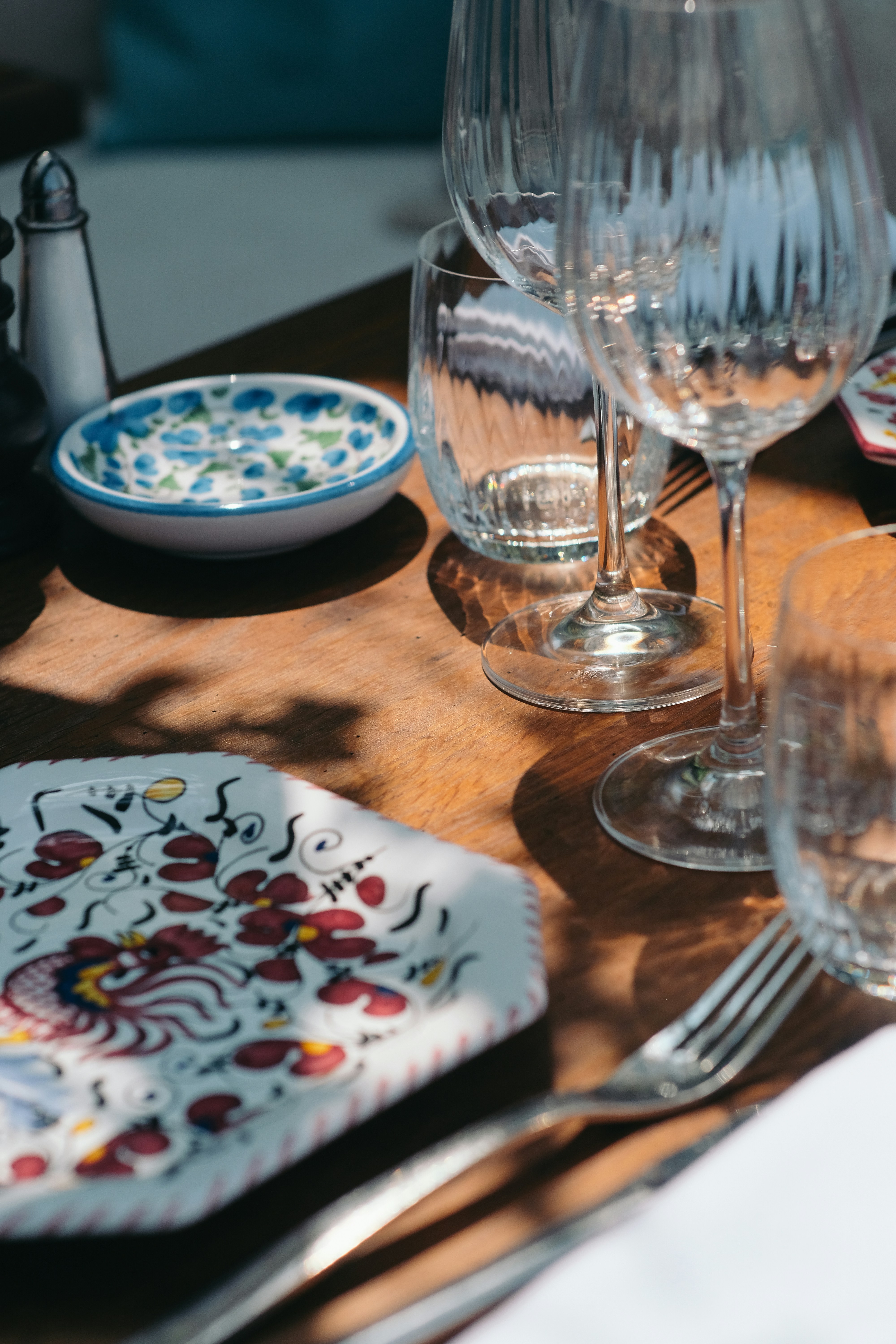 Sunlit Tableware: Crystalline Glass and Floral Ceramics on Wood