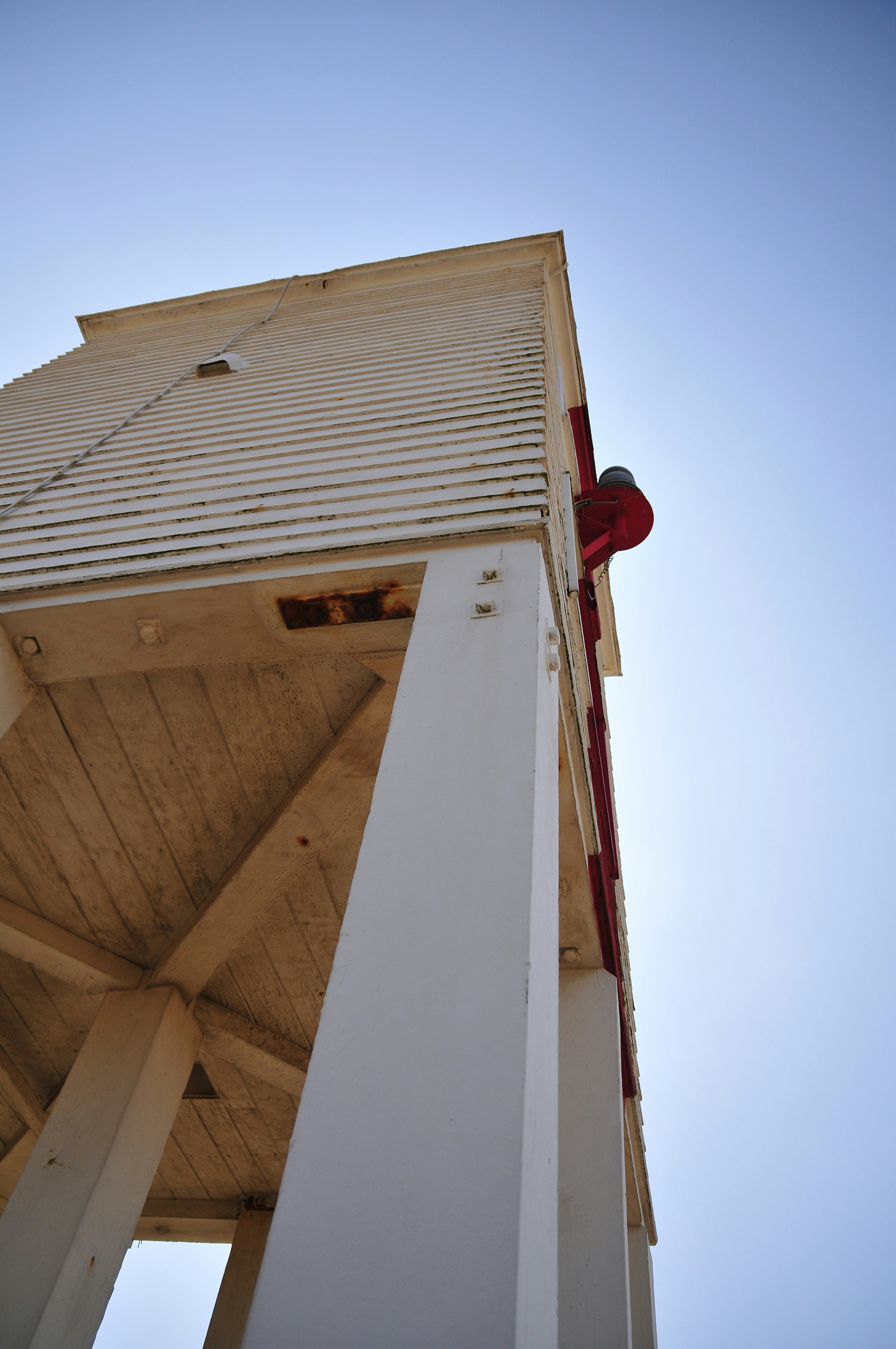Low-Angle Portrait of a Piercing Blue Sky Over a White Coastal Structure