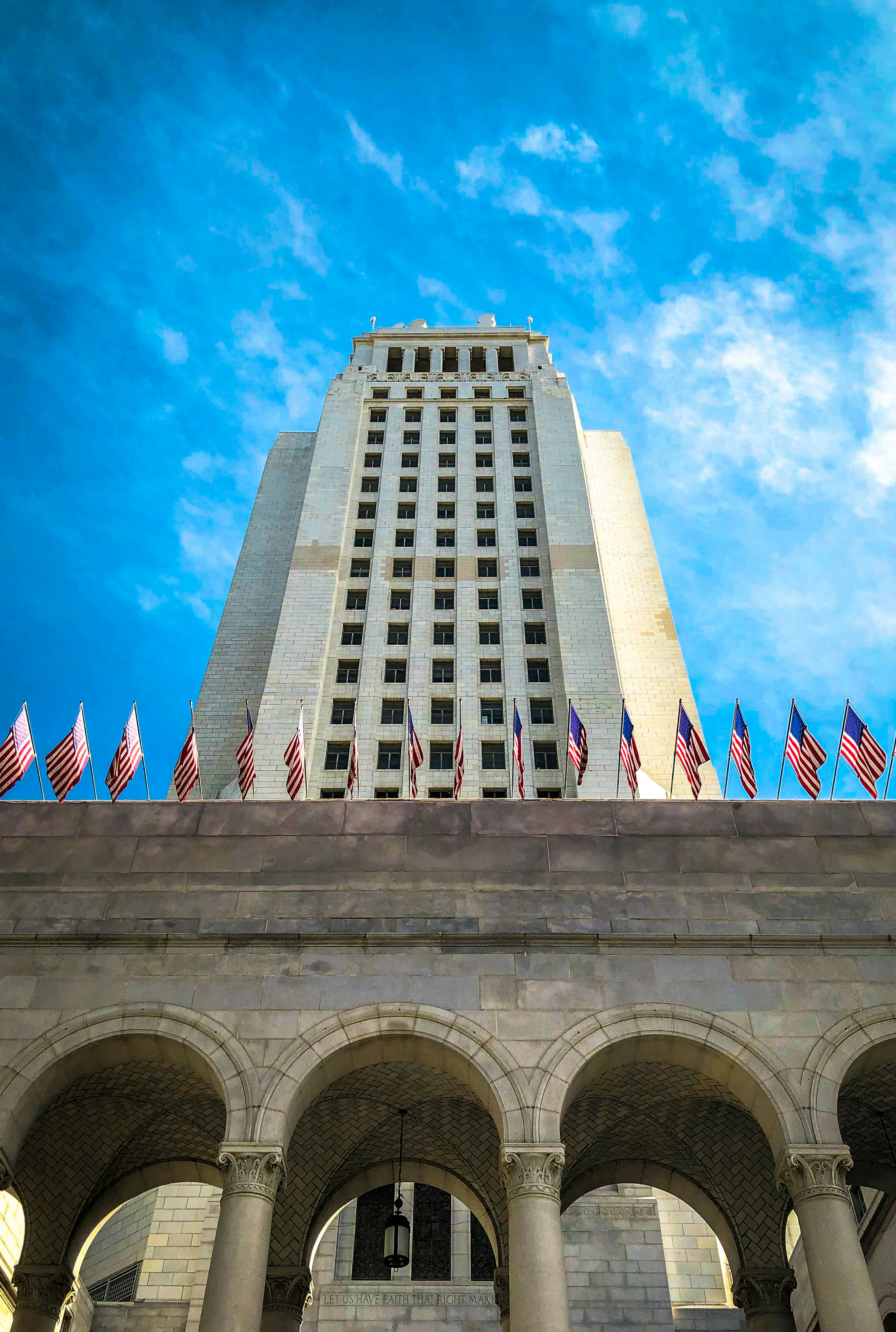 A very tall building with lots of flags on top of it photo – Free Blue ...