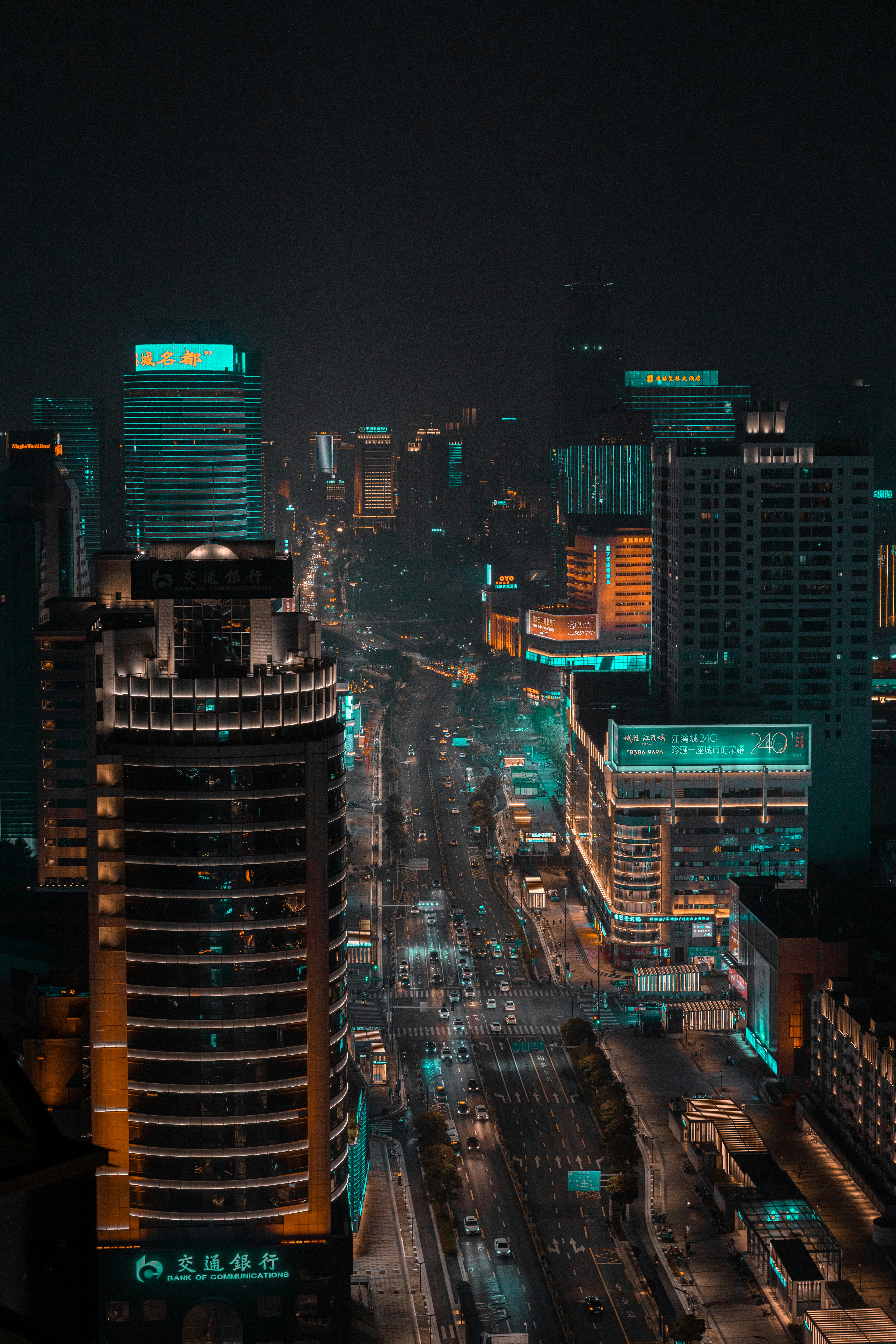 A vibrant city skyline illuminated by neon lights, showcasing bustling streets and towering skyscrapers at night.