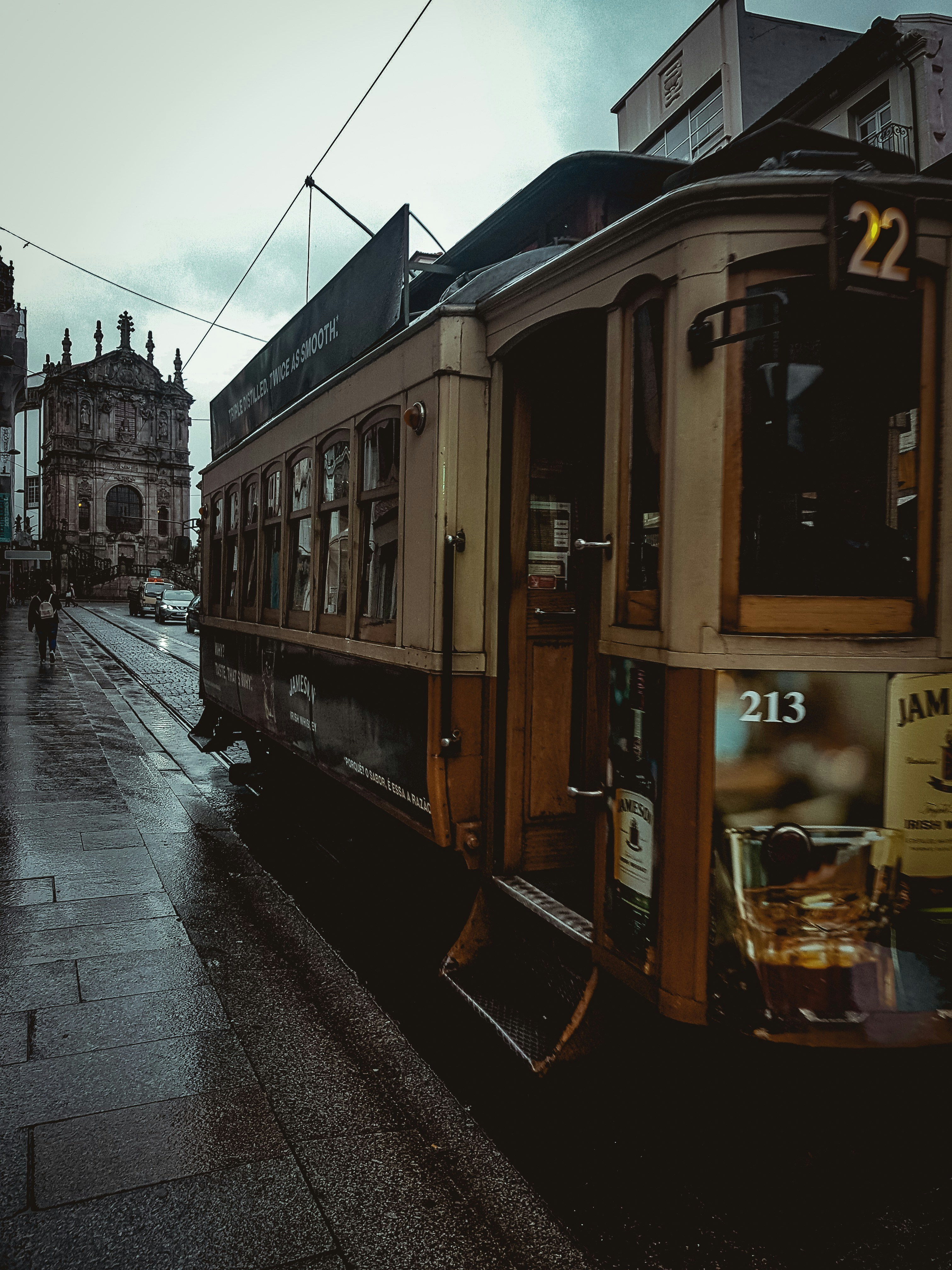 Vintage Tram at a Rain-Slicked City Gate