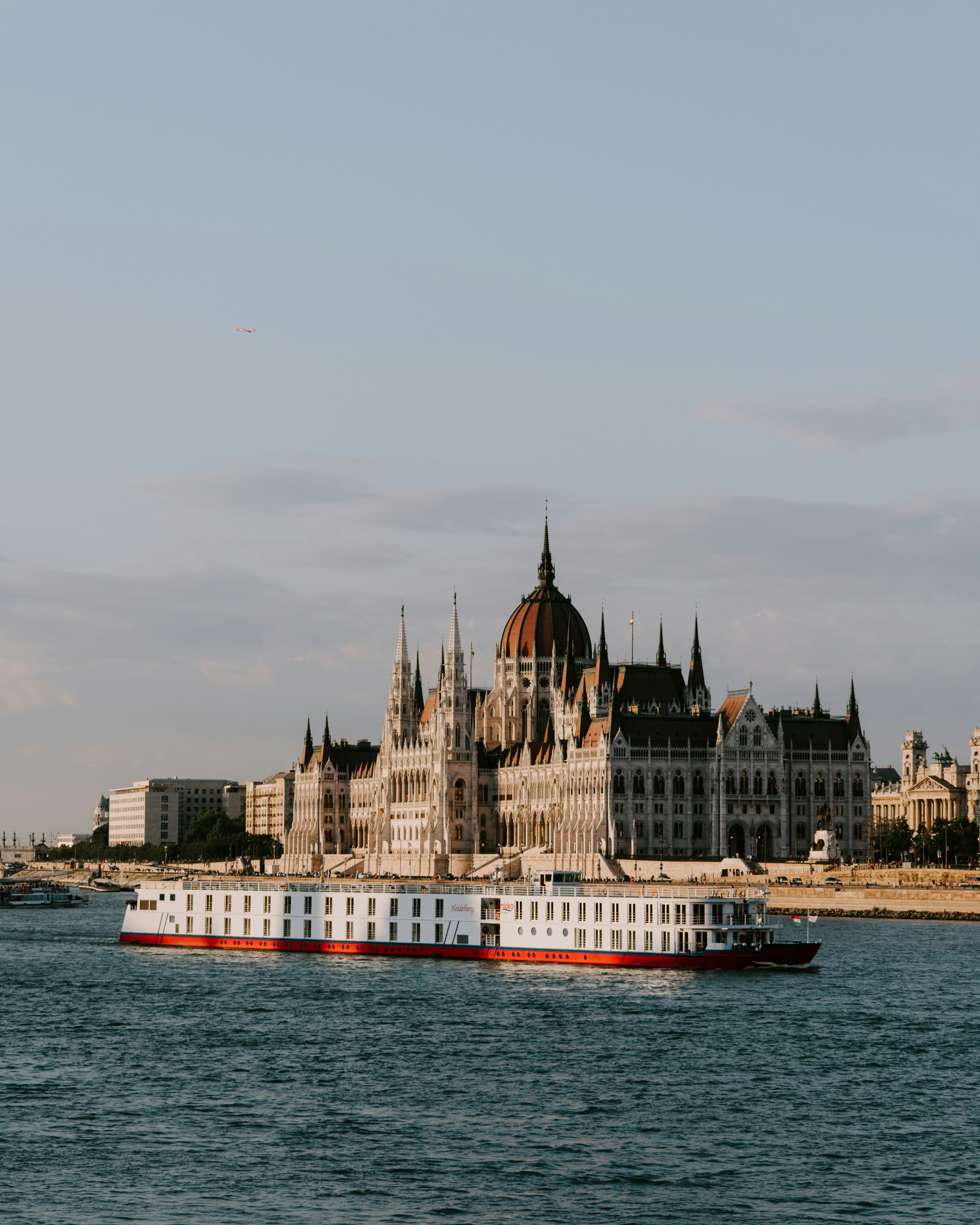 Parliament Dome over the Danube: A River Ferry Traverses Budapest’s Skyline